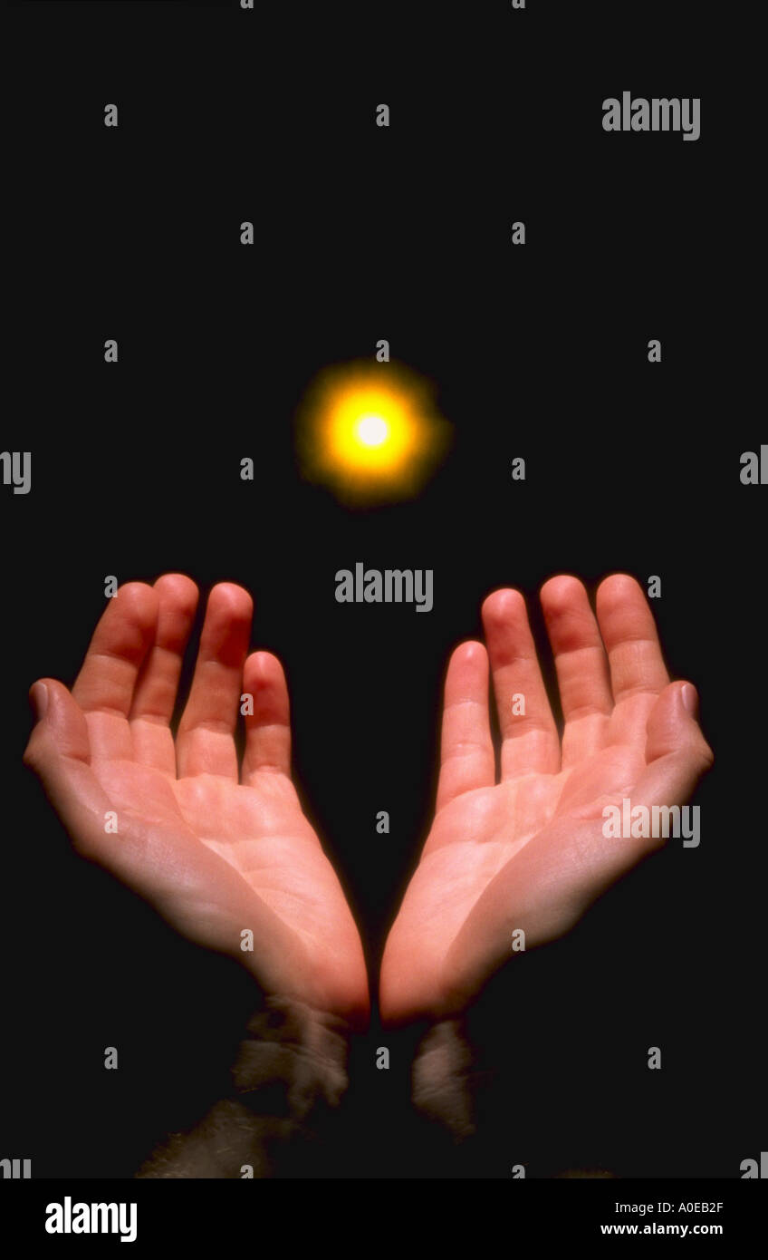Conceptual Open hands with glow of light Stock Photo - Alamy