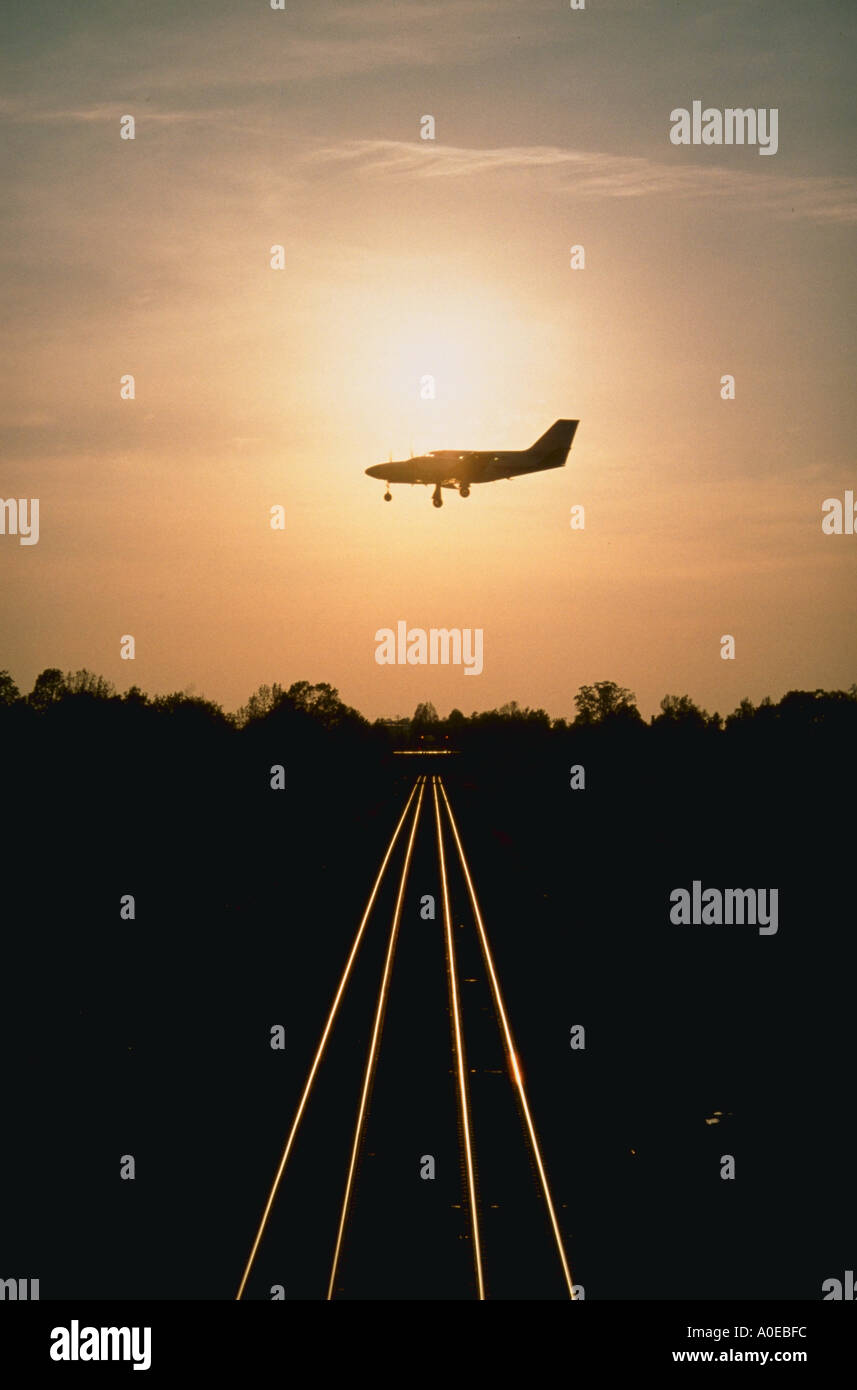 Aircraft flies over railroad Stock Photo - Alamy