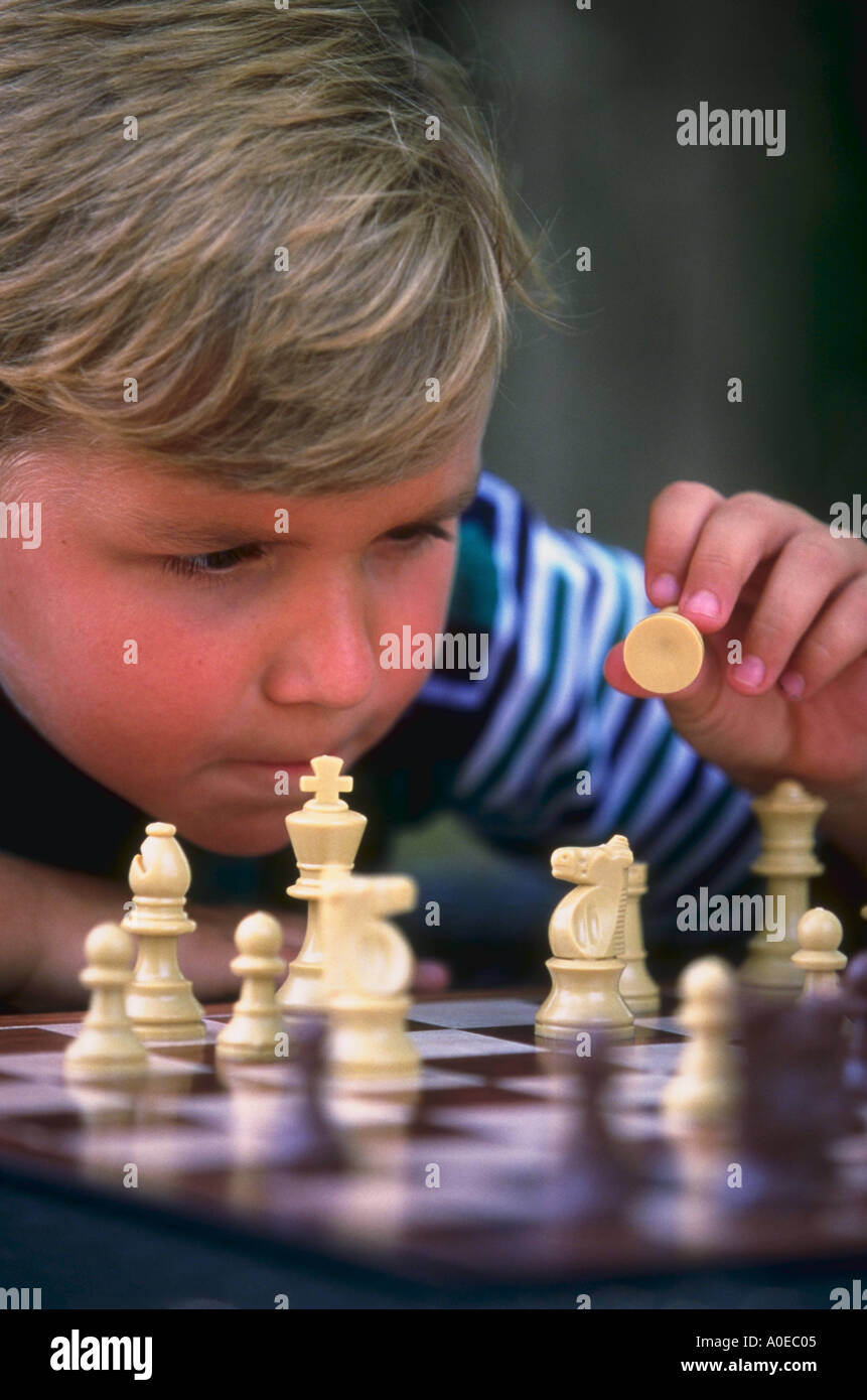 Young boy playing chess Stock Photo - Alamy