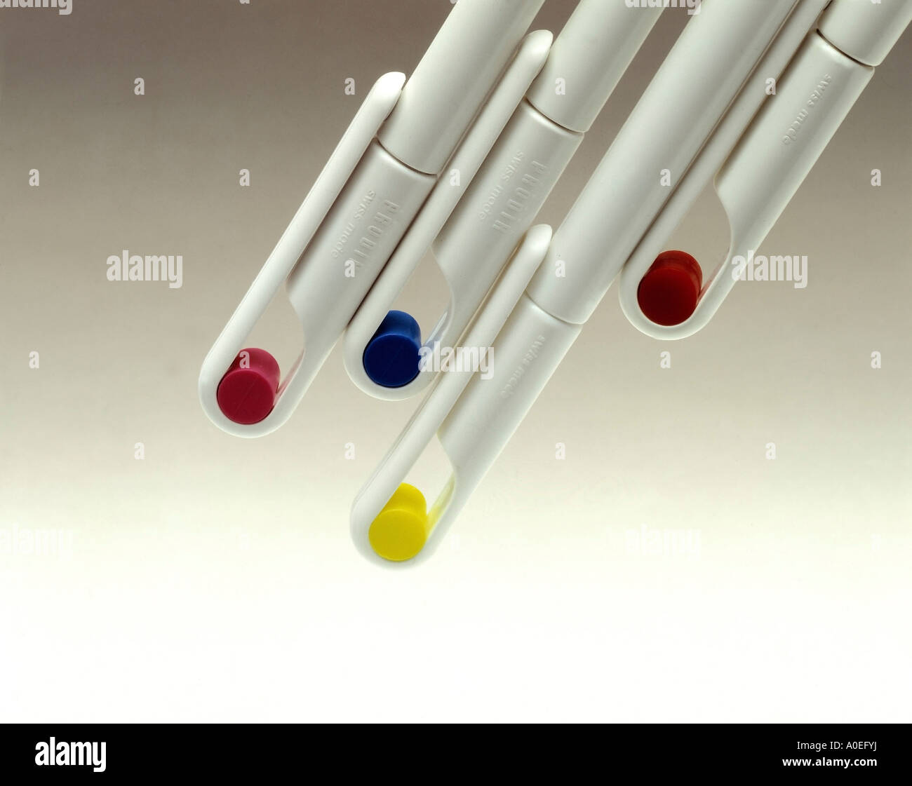 4 pens of different colour on white background Stock Photo - Alamy