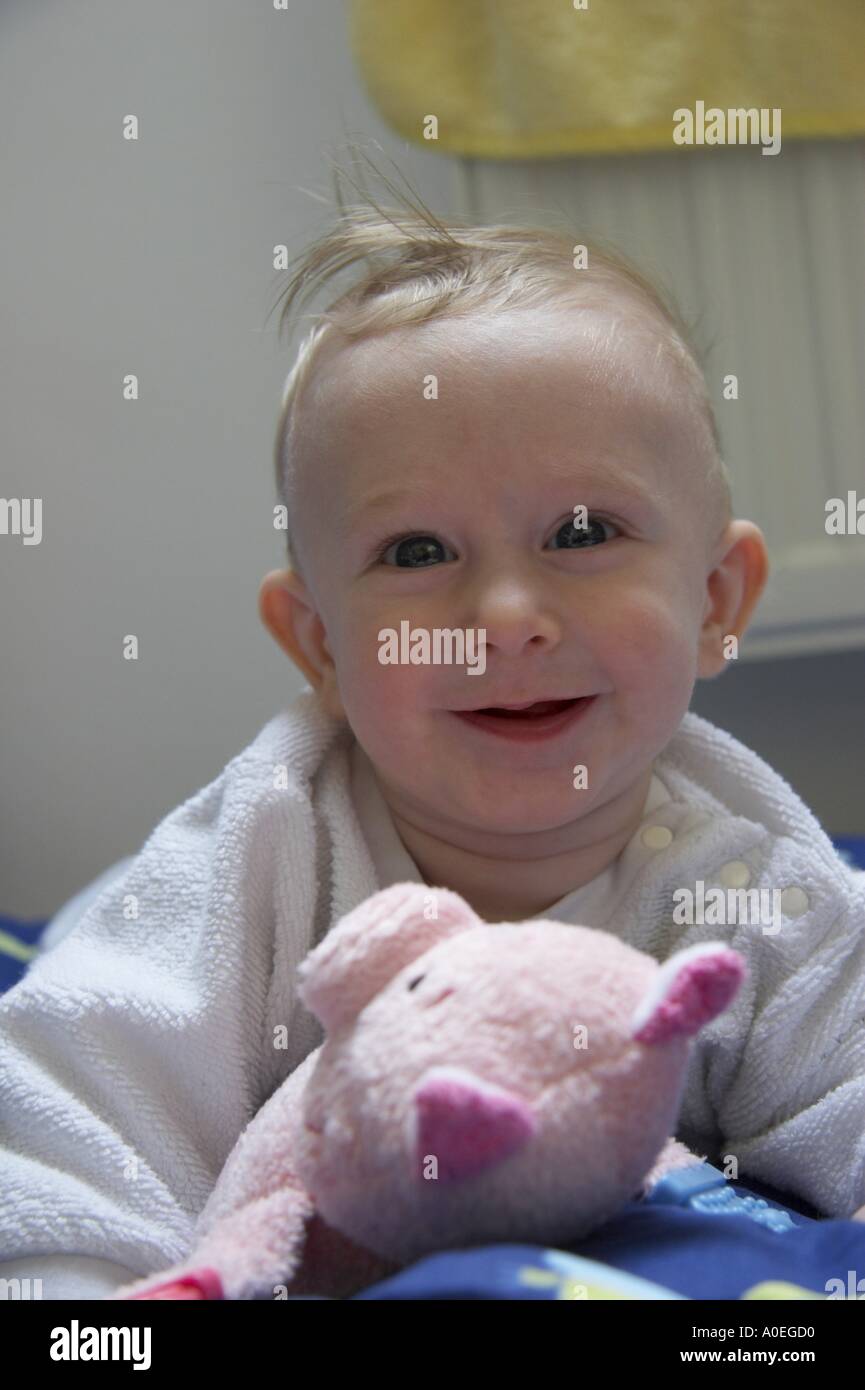baby with soft toy, smiling Stock Photo - Alamy