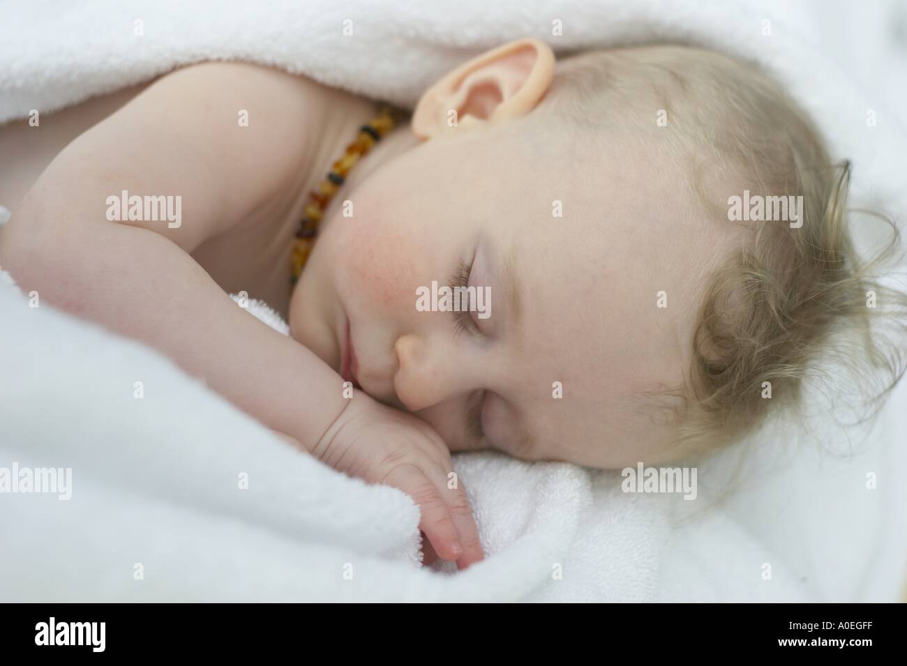 sleeping baby / white terry cloth Stock Photo - Alamy