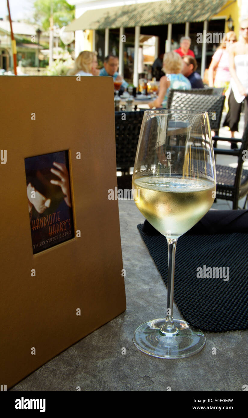 Glass of white wine and a menu Stock Photo - Alamy