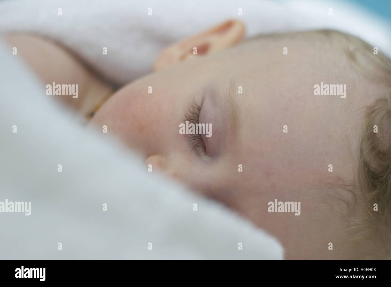 sleeping baby / white terry cloth Stock Photo - Alamy