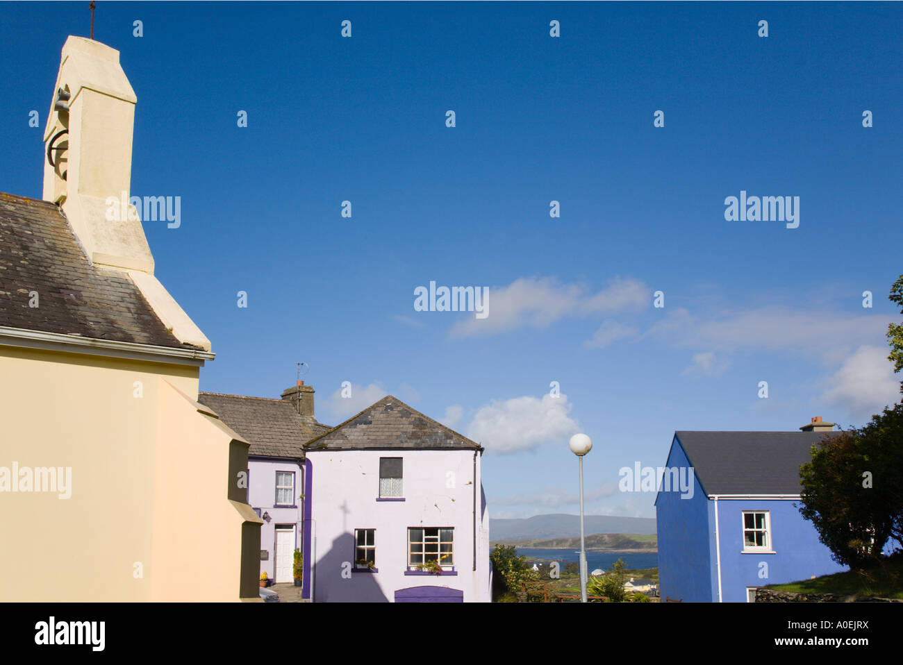 Church with cross shadow on pub in historic village on "Ring of Beara ...