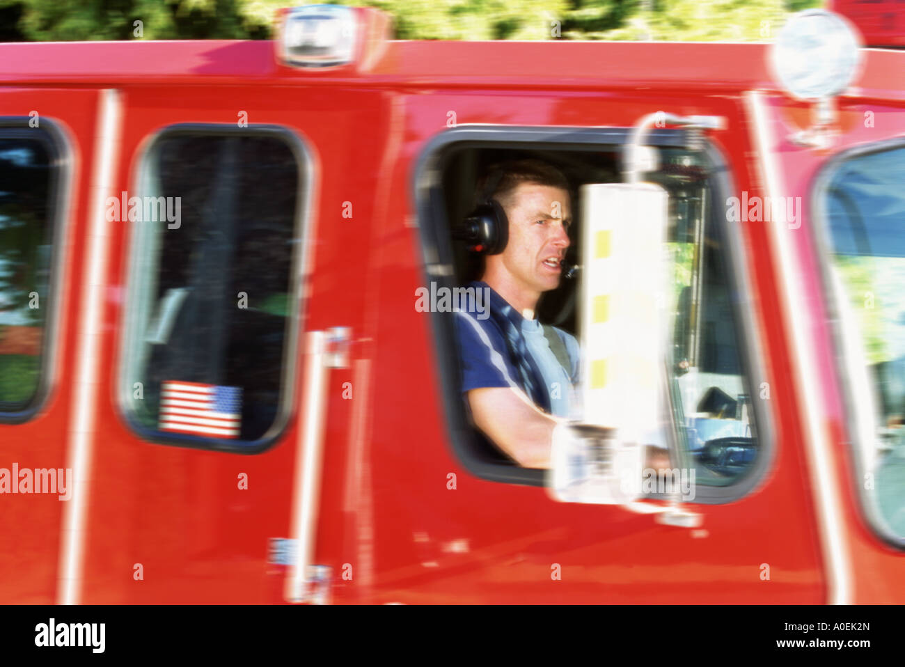 Male firefighter in moving fire truck Stock Photo - Alamy