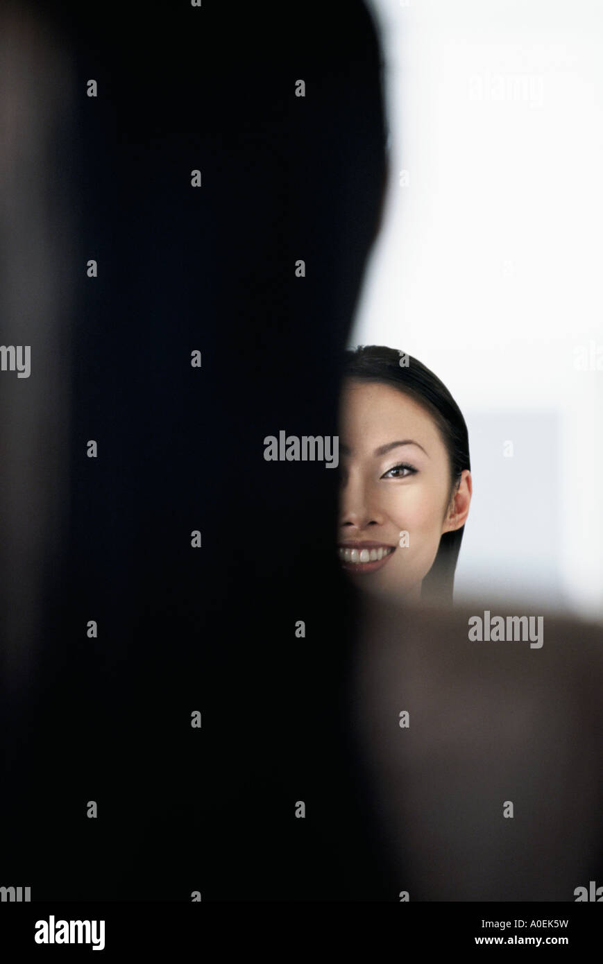 Womans back with her smiling reflection in mirror Stock Photo - Alamy