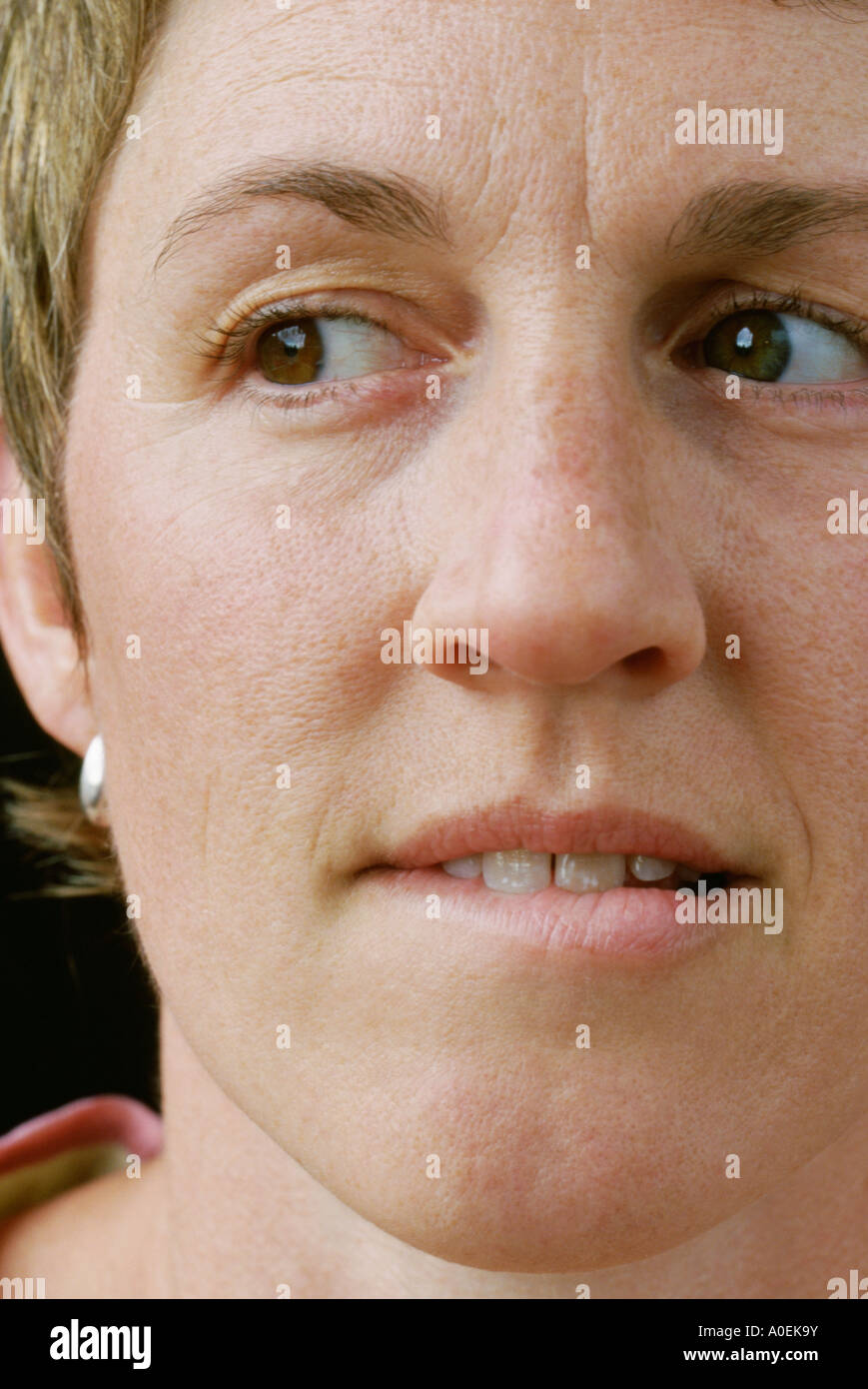 Shy woman biting lip hi-res stock photography and images - Alamy