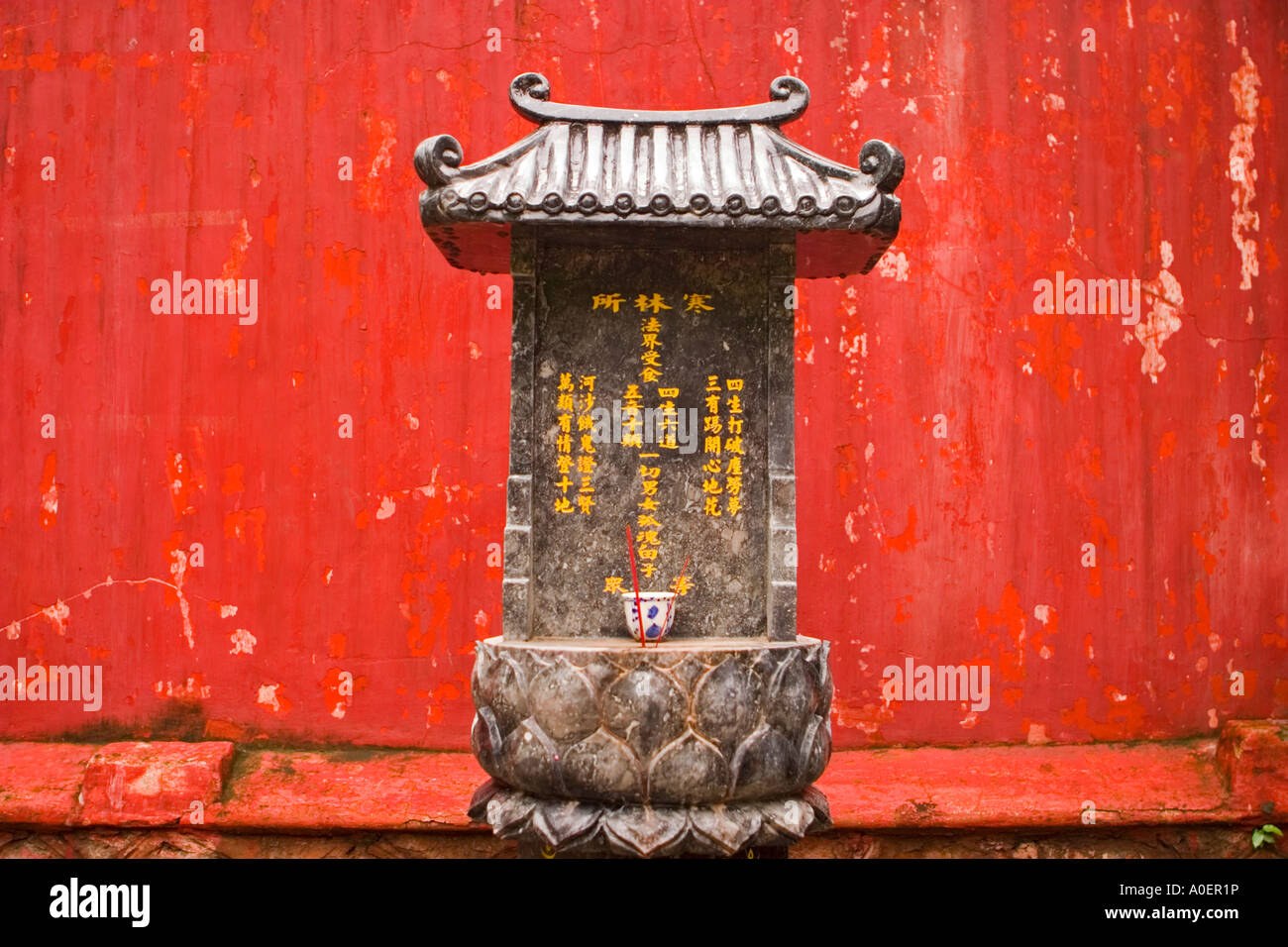 A temple marker with Chinese characters showing in contrast against a ...