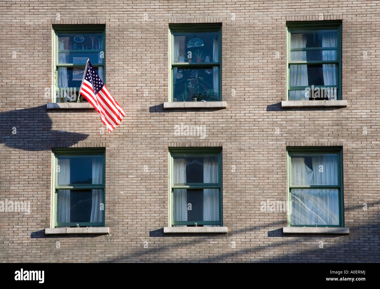 Apartment windows in building with American flag flying from one ...