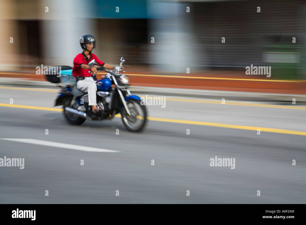 Motorcycle rider; city street Stock Photo - Alamy
