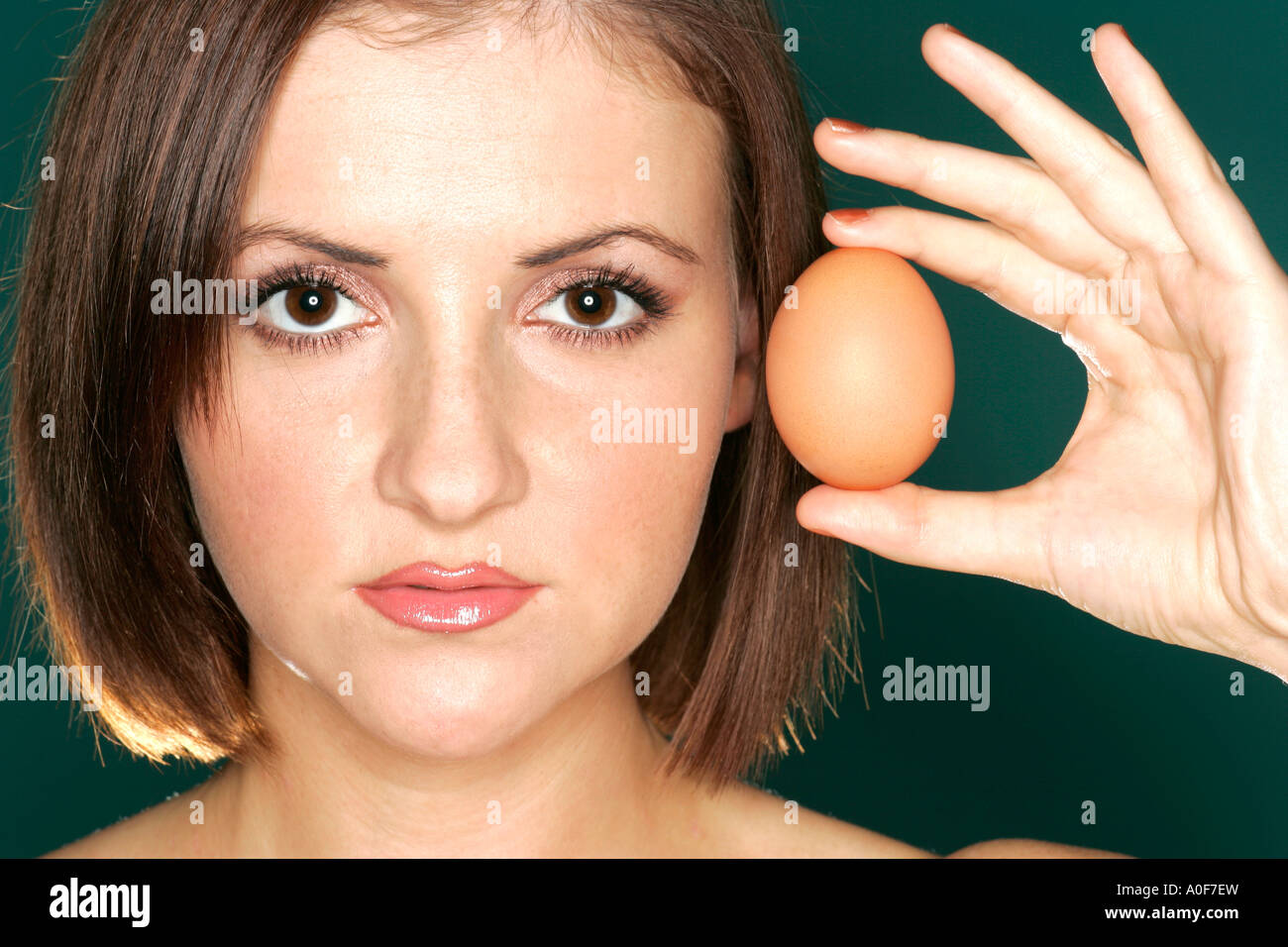 Woman holding egg Stock Photo - Alamy