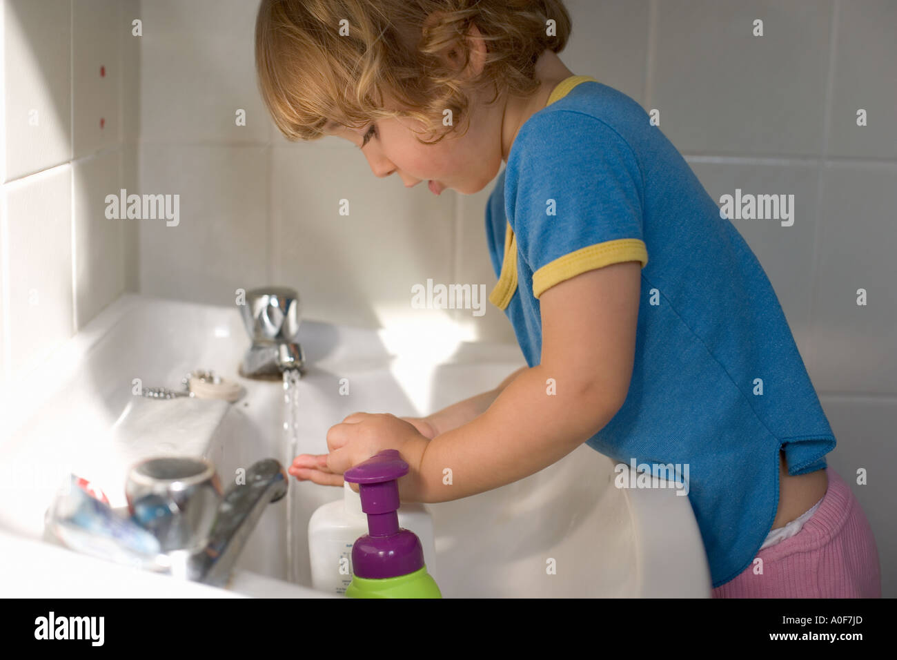 Young child washing hands in bathroom Stock Photo - Alamy