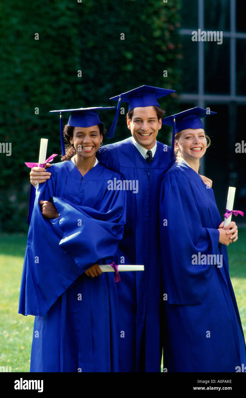 Two female graduates and a male graduate holding diplomas Stock Photo ...