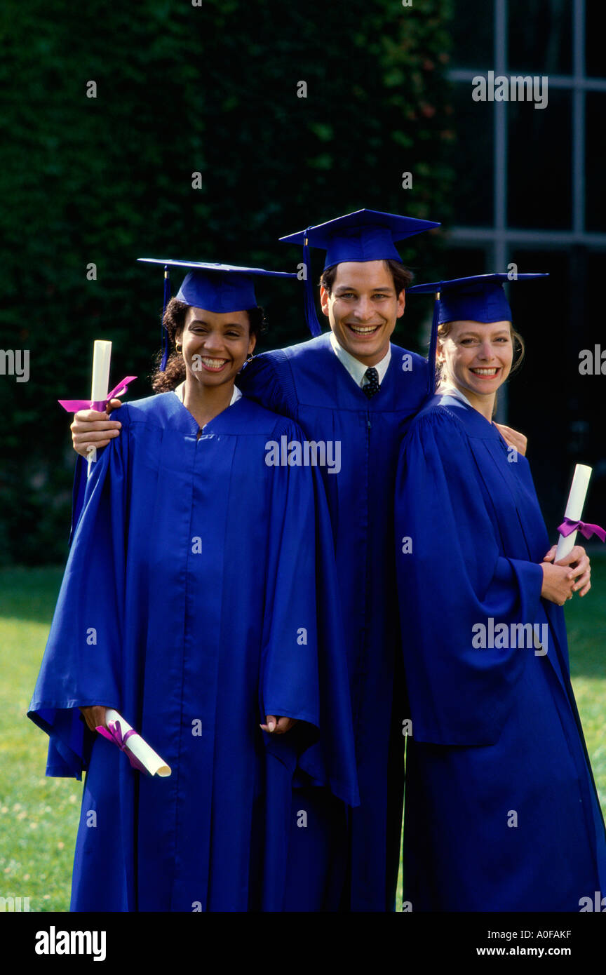 Two female graduates and a male graduate holding diplomas Stock Photo ...