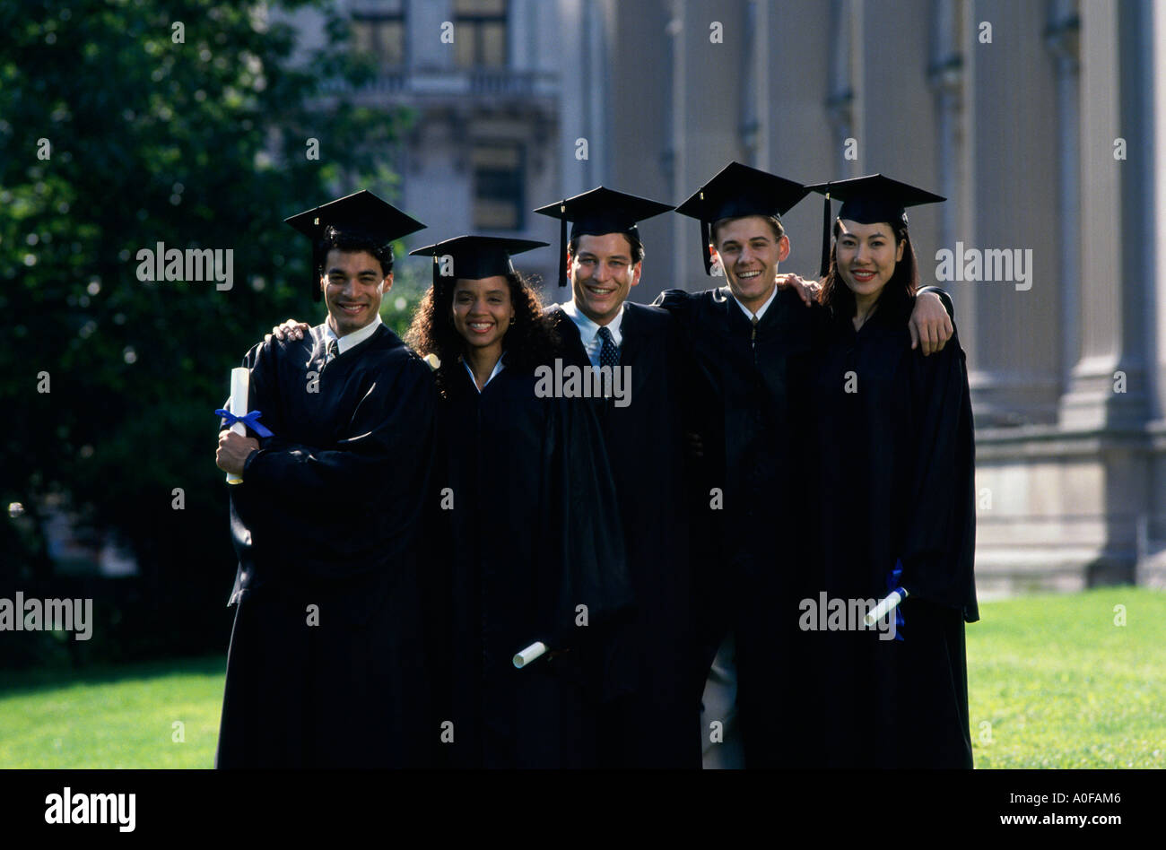 Two female graduates and three male graduates holding diplomas Stock ...