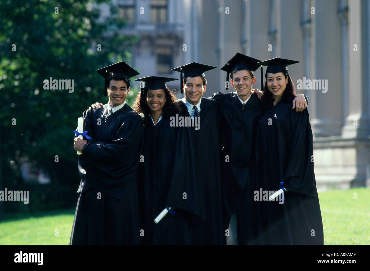 Two female graduates and three male graduates holding diplomas Stock ...