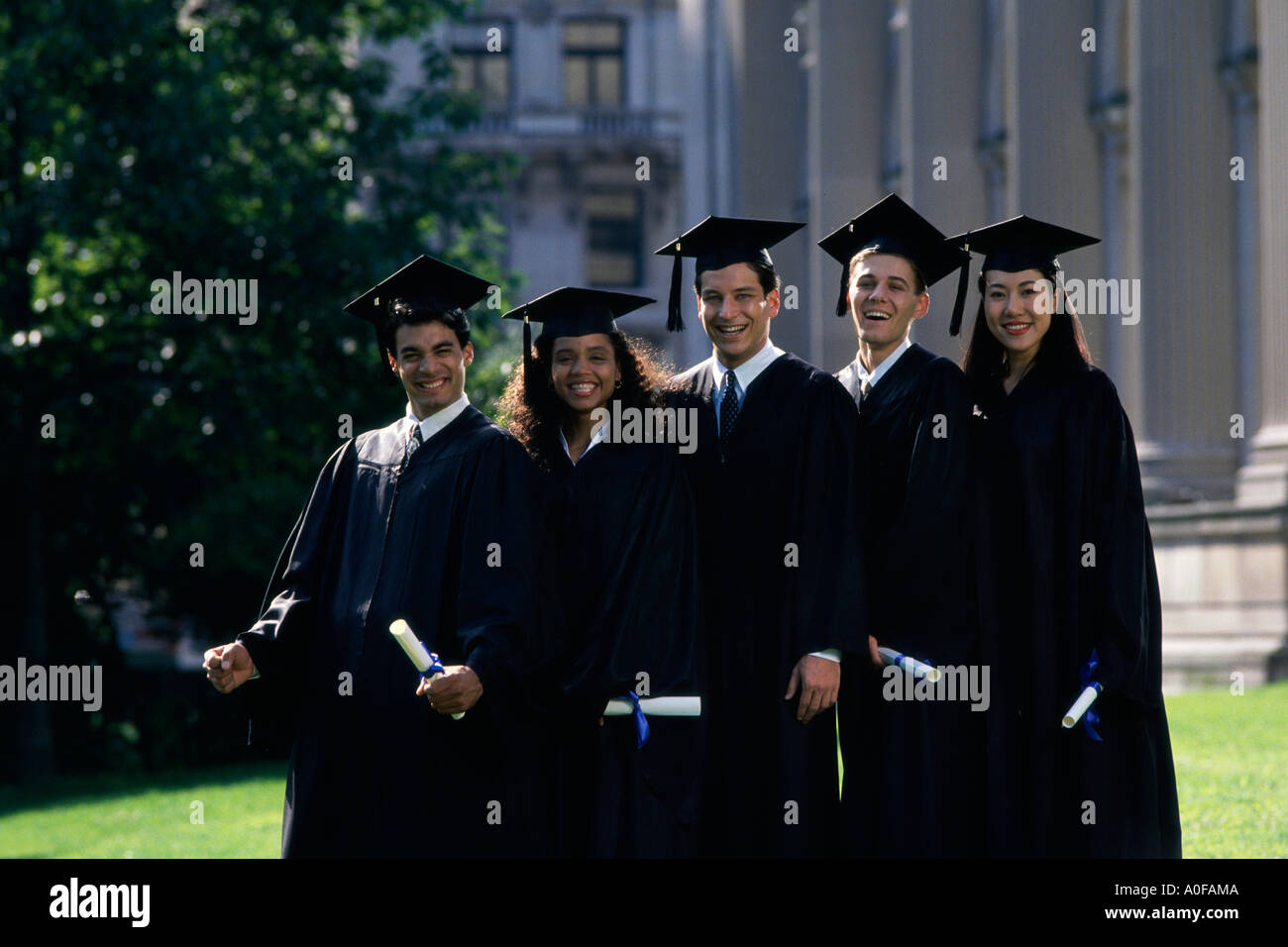 Two female graduates and three male graduates holding diplomas Stock ...