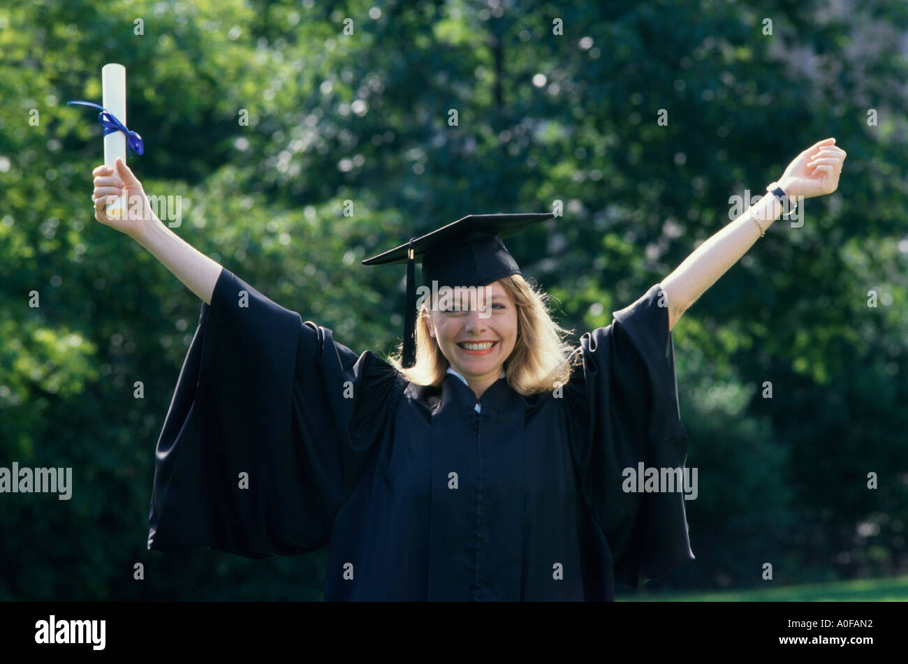 Portrait of a female graduate holding a diploma Stock Photo - Alamy