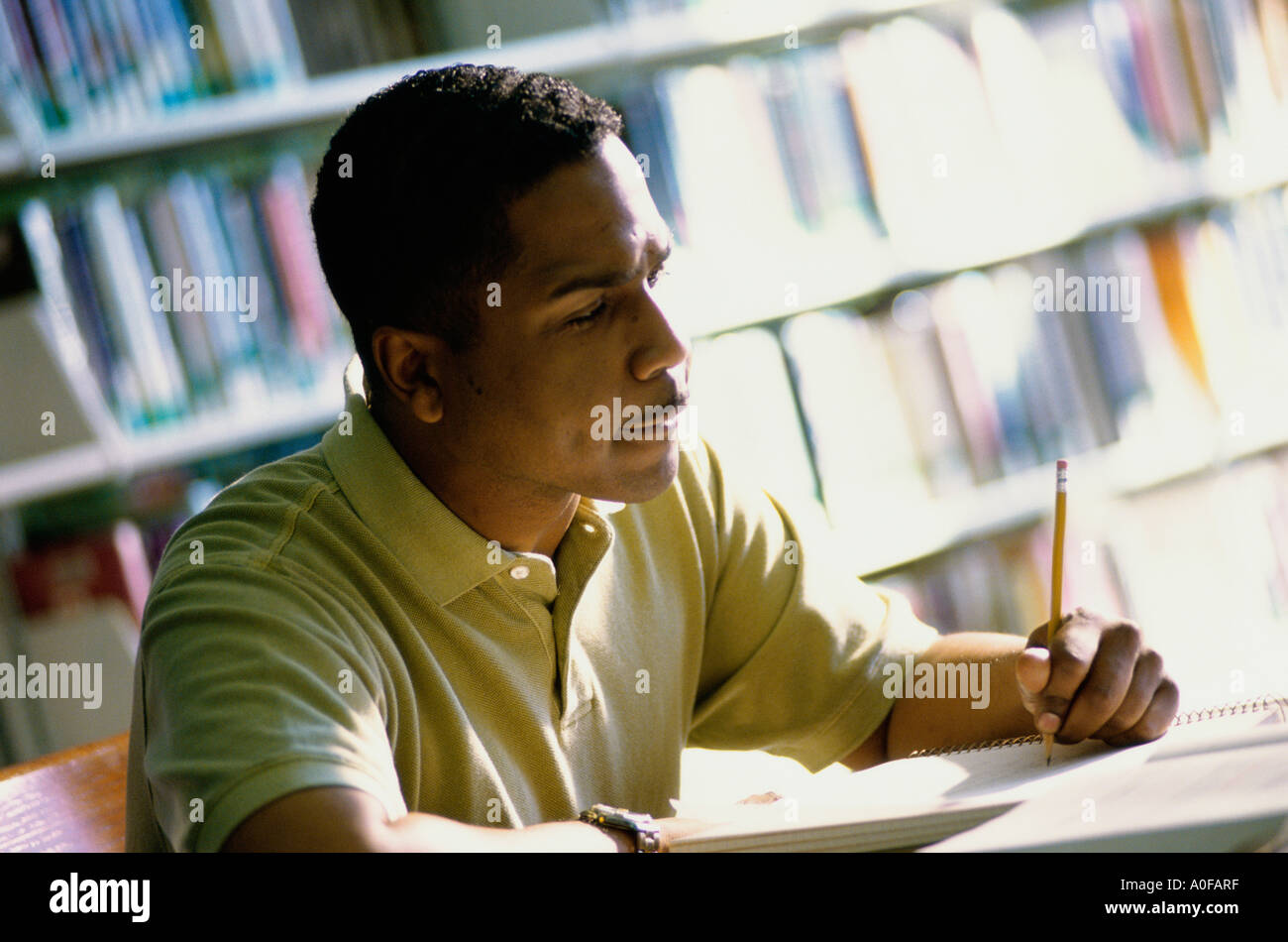 Pensive african man writing in hi-res stock photography and images - Alamy
