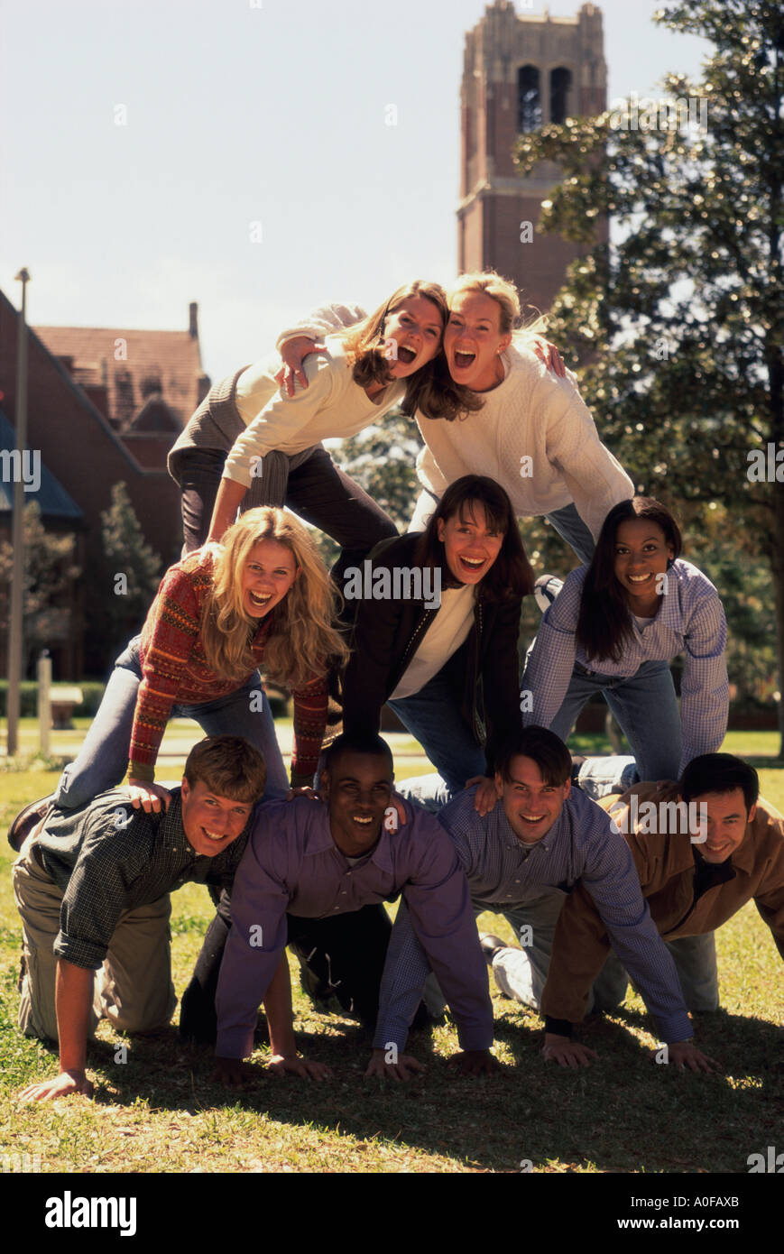 Group of young people making a human pyramid Stock Photo - Alamy