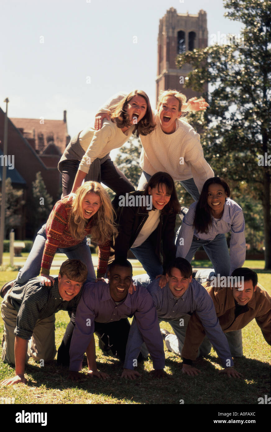 Group of young people making a human pyramid Stock Photo - Alamy