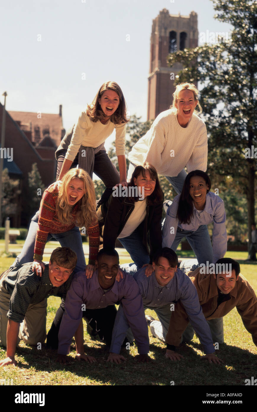 Group of young people making a human pyramid Stock Photo - Alamy