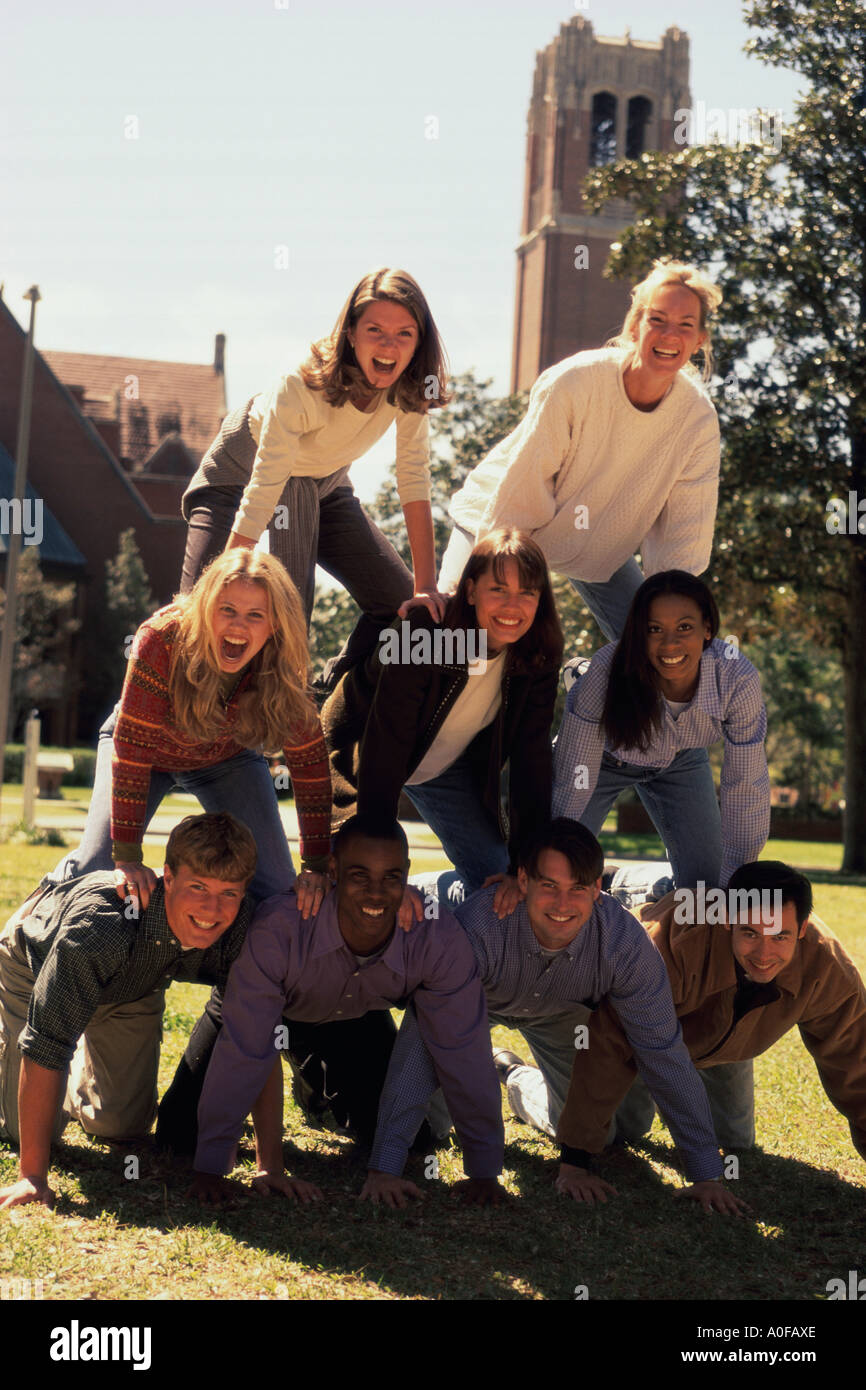 Group of young people making a human pyramid Stock Photo - Alamy