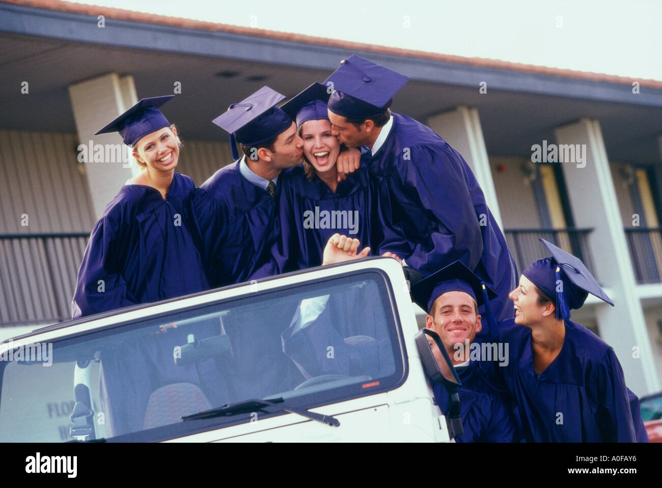 Group of graduates in a jeep Stock Photo - Alamy