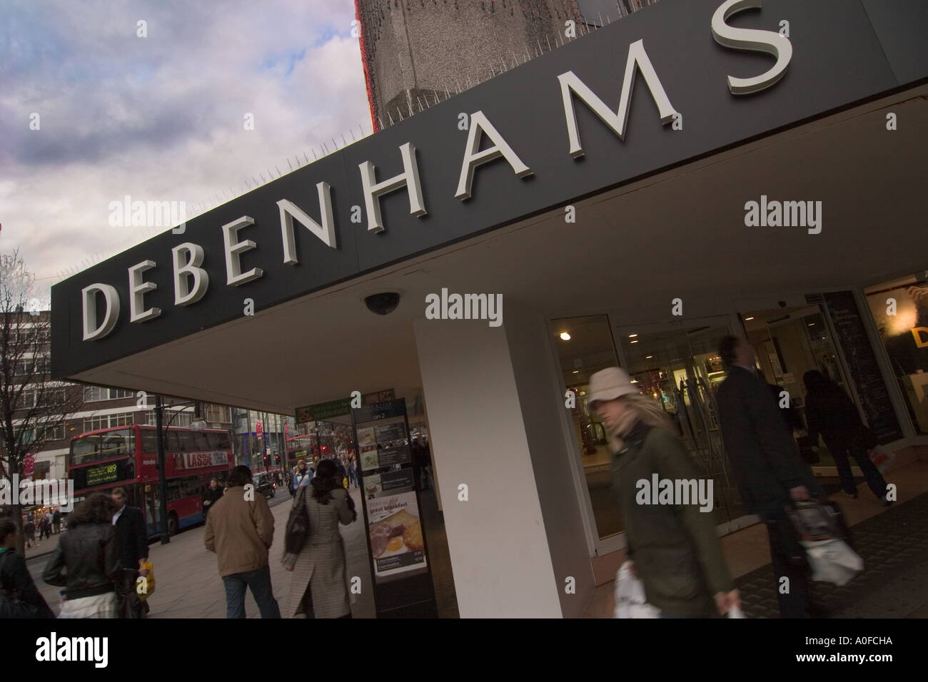 Shoppers walk past Debenhams department store on Oxford Street, London ...