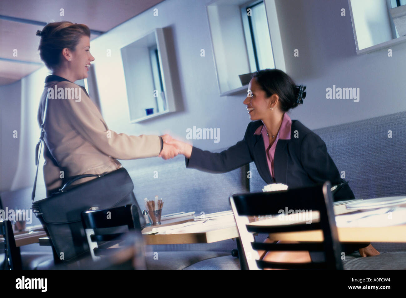 Women handshake restaurant hi-res stock photography and images - Alamy