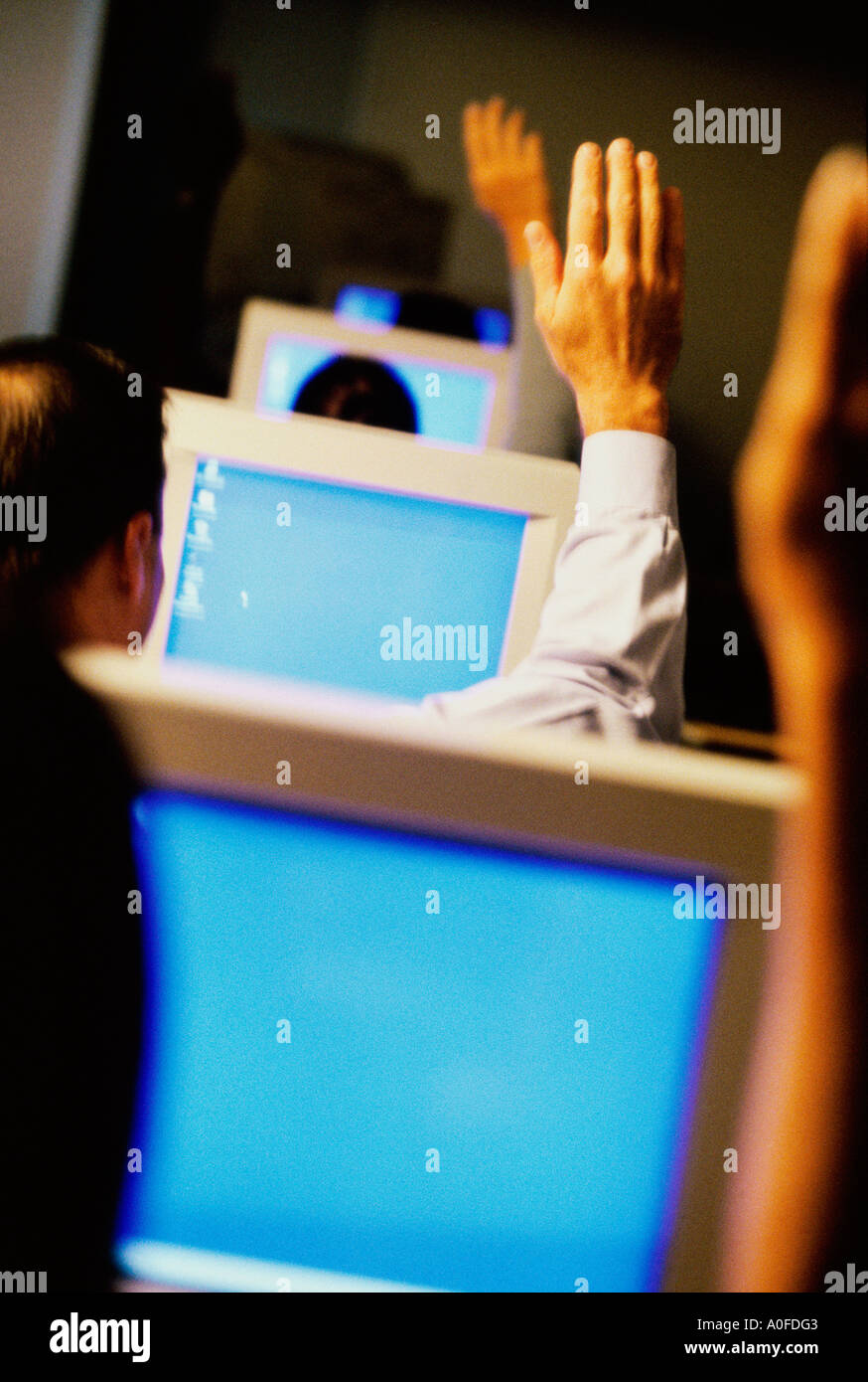 Business executives with their hands raised Stock Photo - Alamy