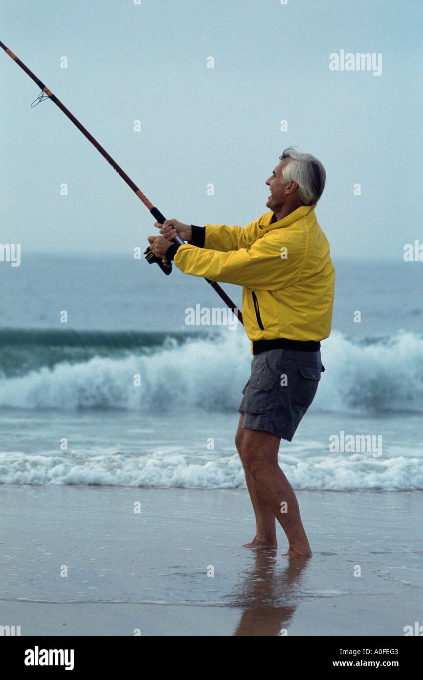 Side profile of a senior man fishing at the beach Stock Photo - Alamy