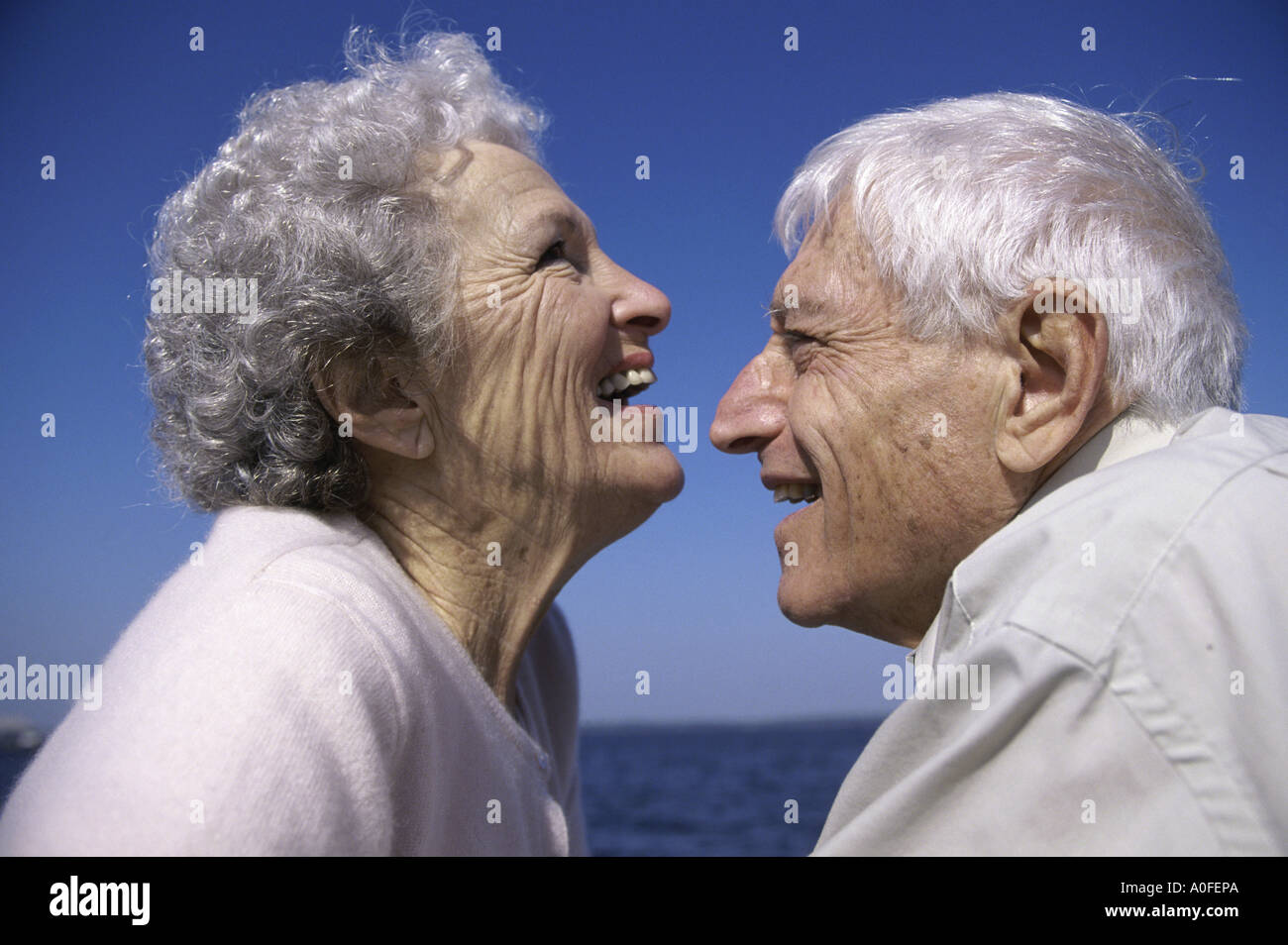 Side profile of a senior couple laughing Stock Photo - Alamy