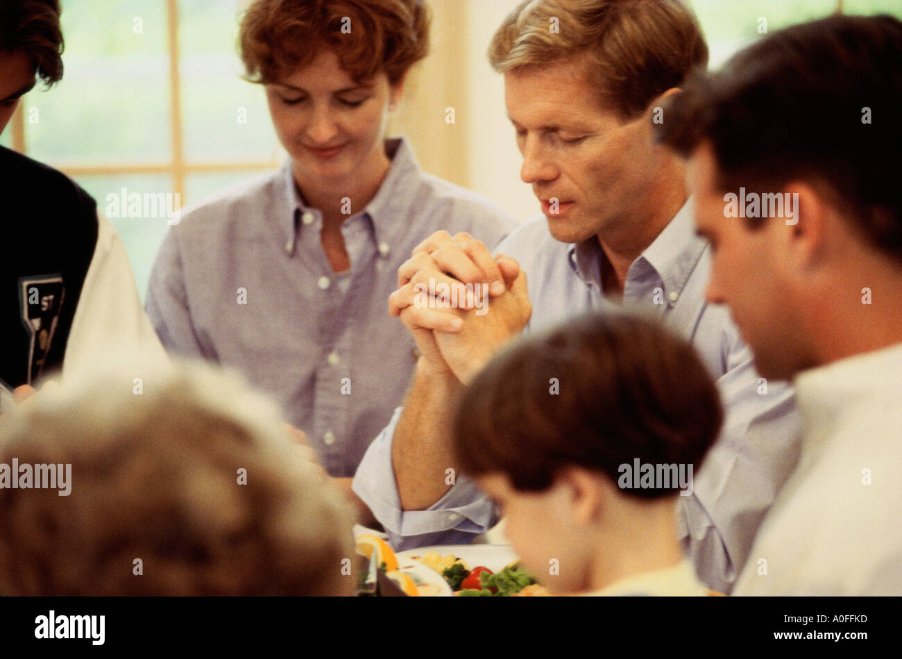 Group of people praying Stock Photo - Alamy