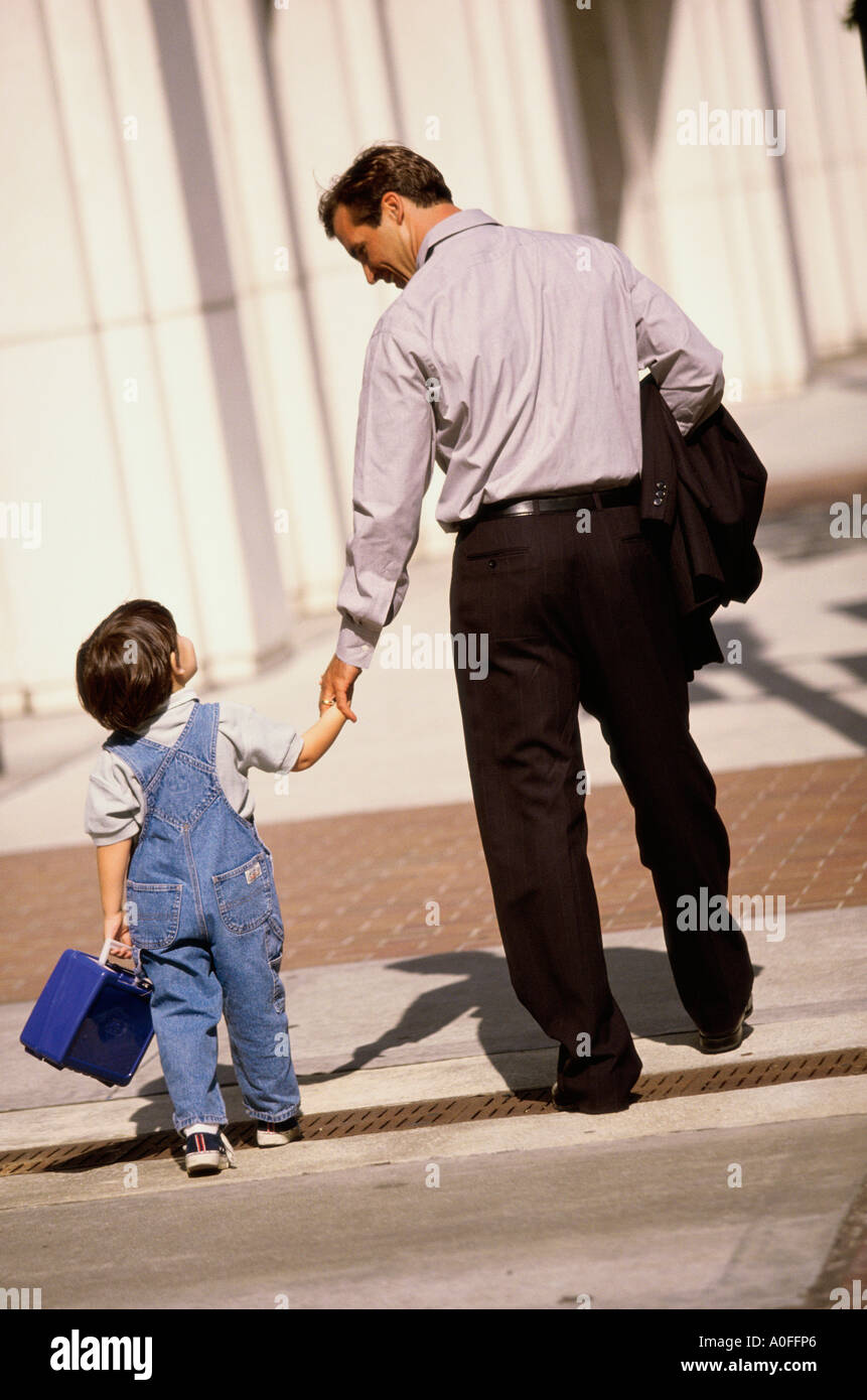 Rear view of a father walking with his son Stock Photo - Alamy