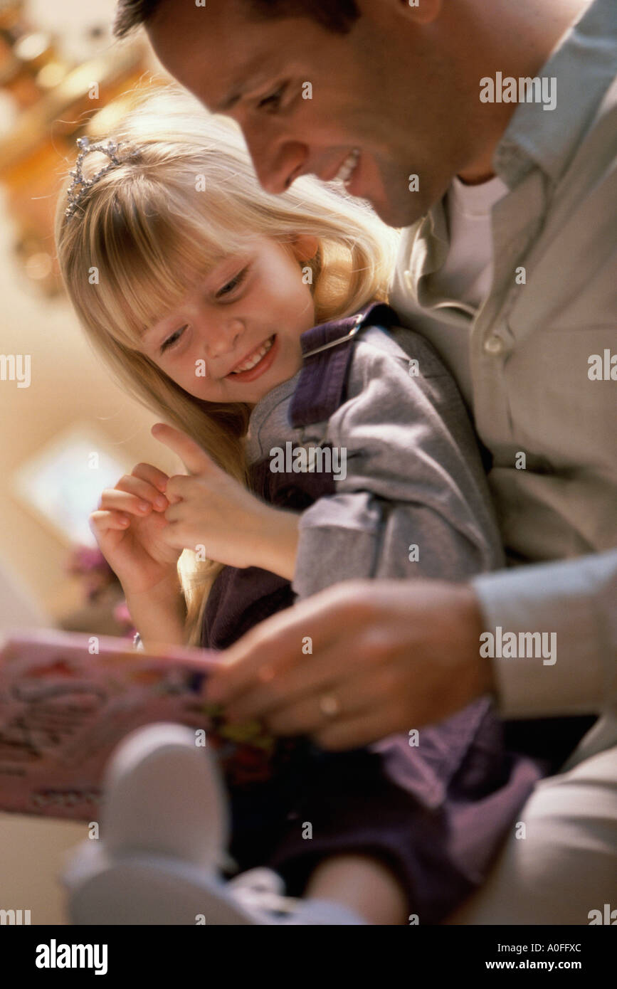 Close-up of a father reading to his daughter Stock Photo - Alamy