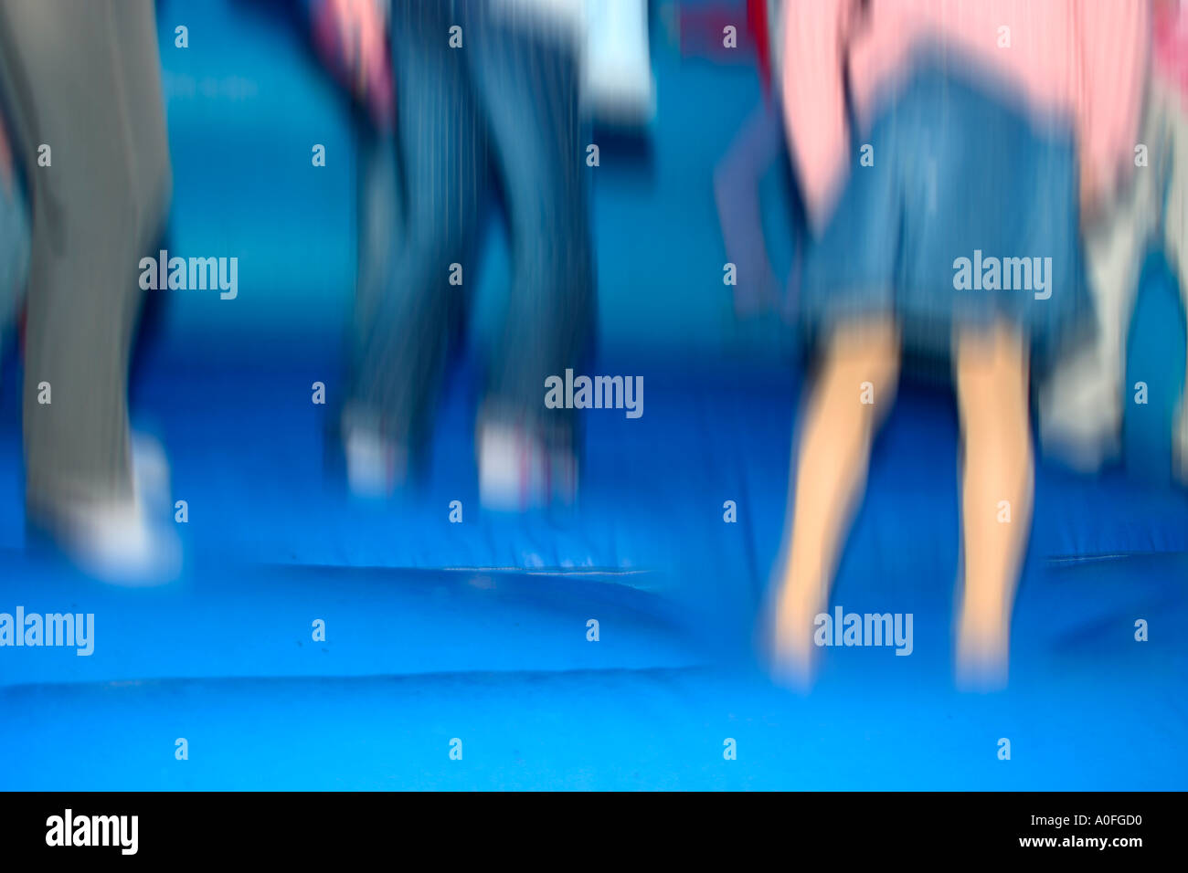 Legs of young girls and boys bouncing on bouncy castle inflatable with ...