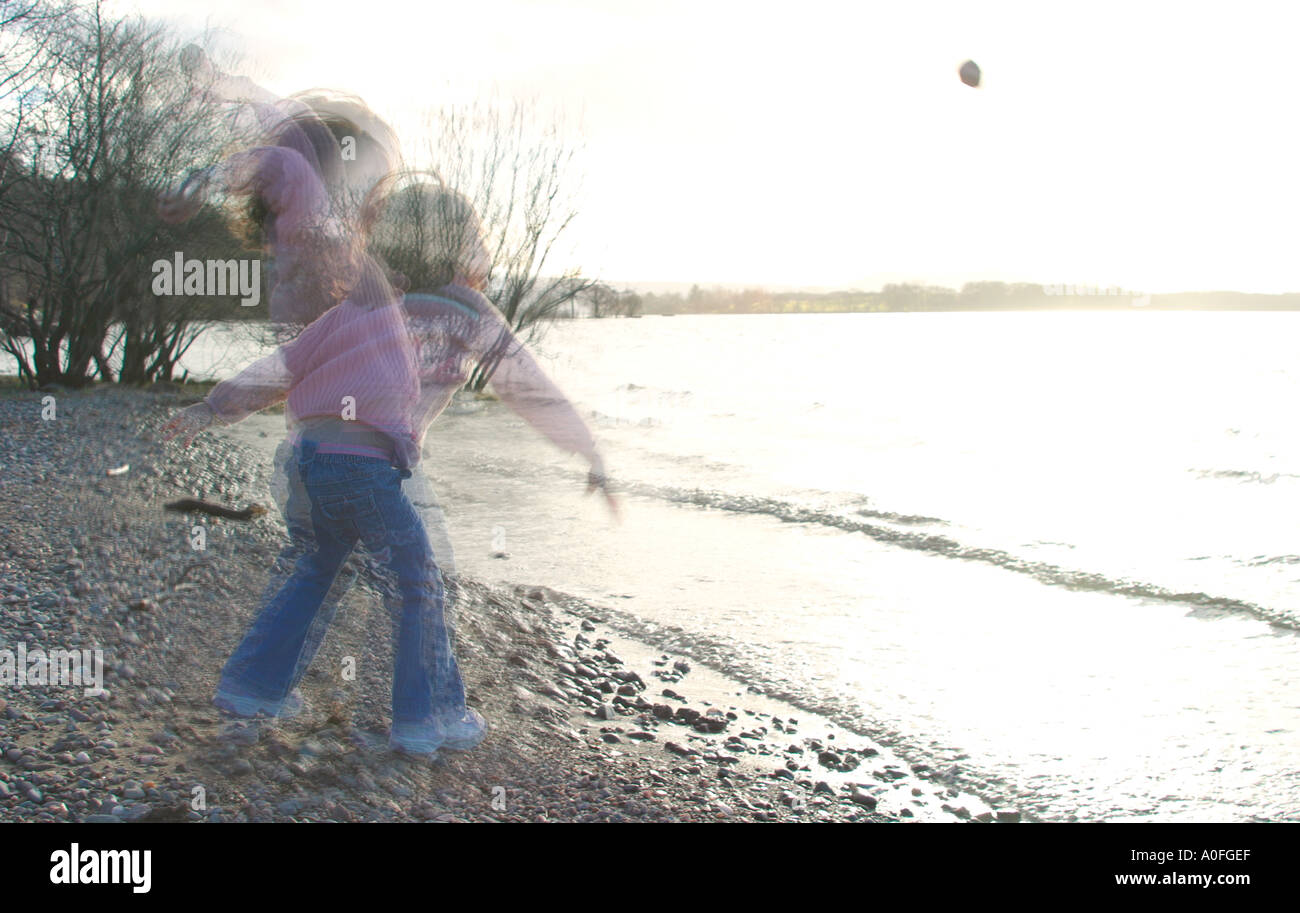Composite of young girl throwing stone into water at Loch Lomond ...