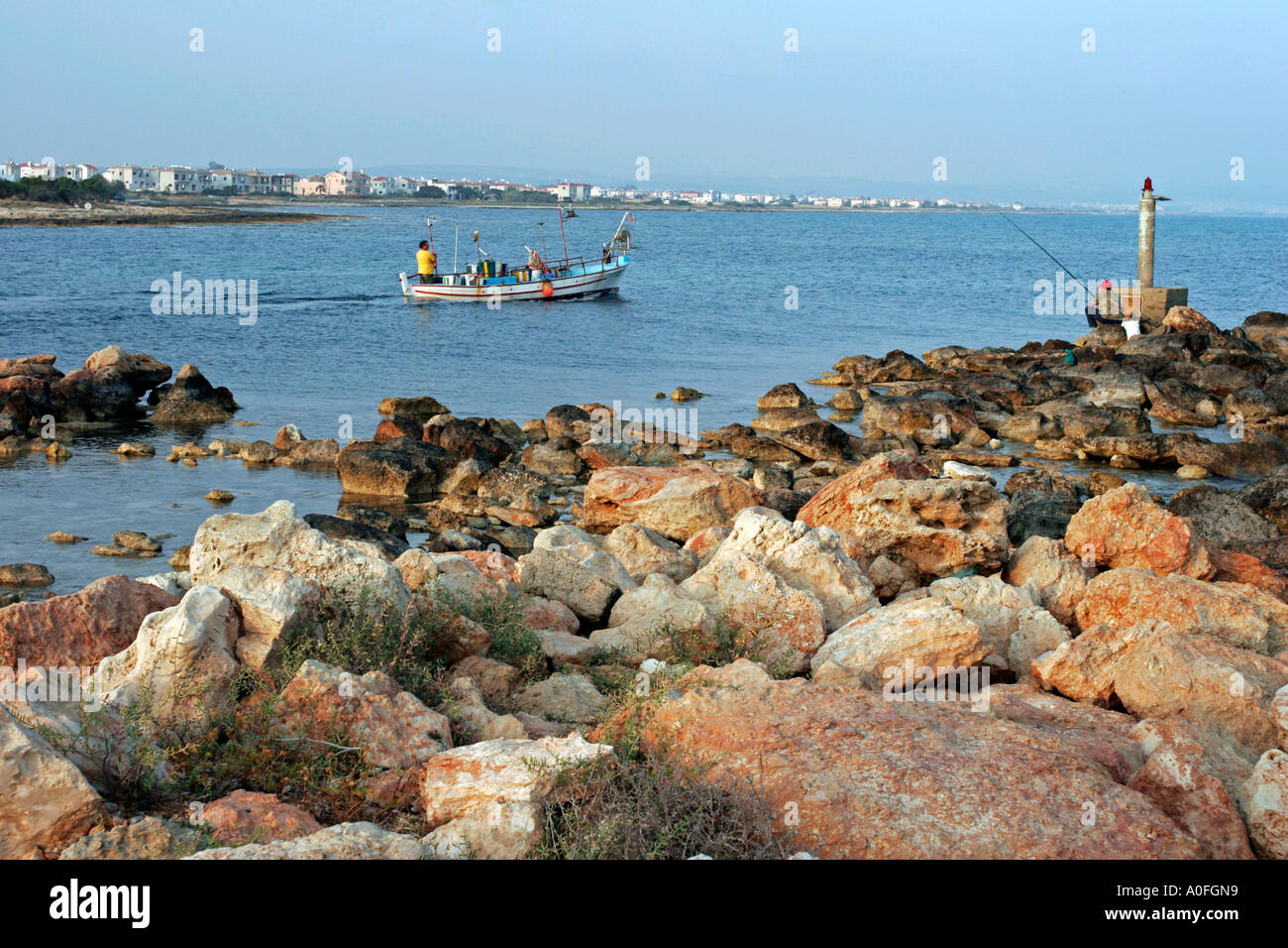 Cyprus scene at Potamos Harbor with a fishing boat Stock Photo - Alamy