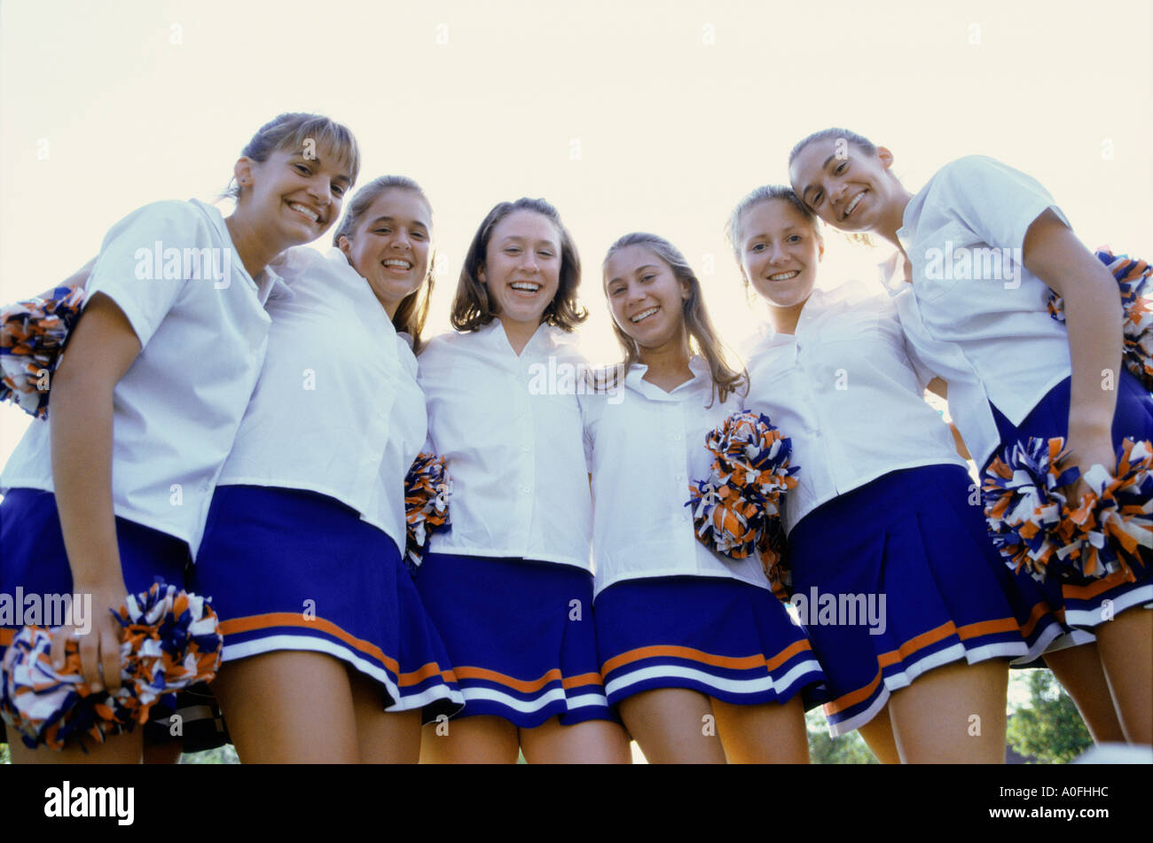Low angle view of a group of cheerleaders smiling Stock Photo - Alamy