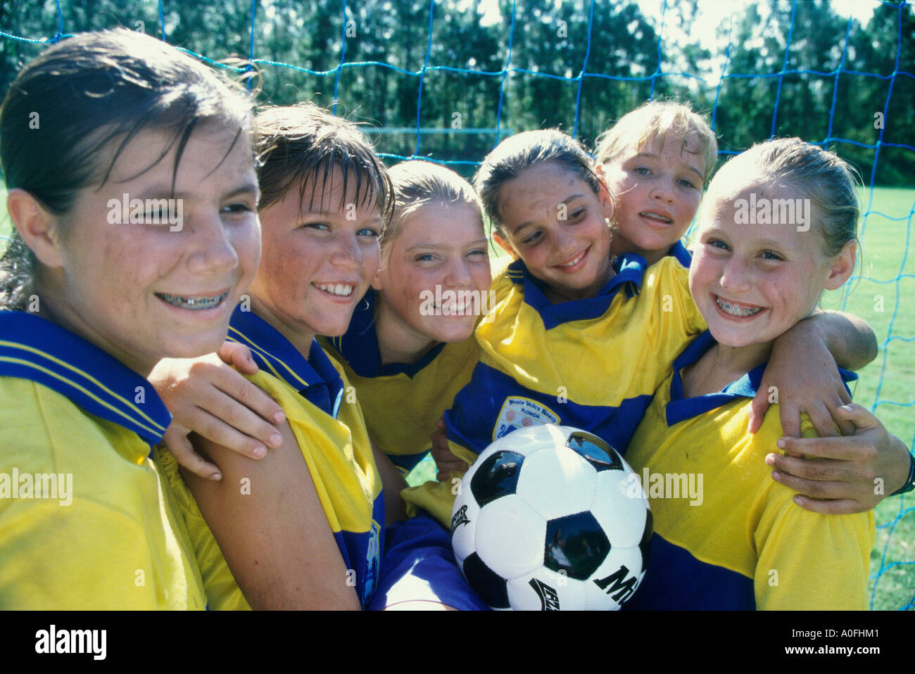 Portrait of a smiling girls soccer team Stock Photo - Alamy
