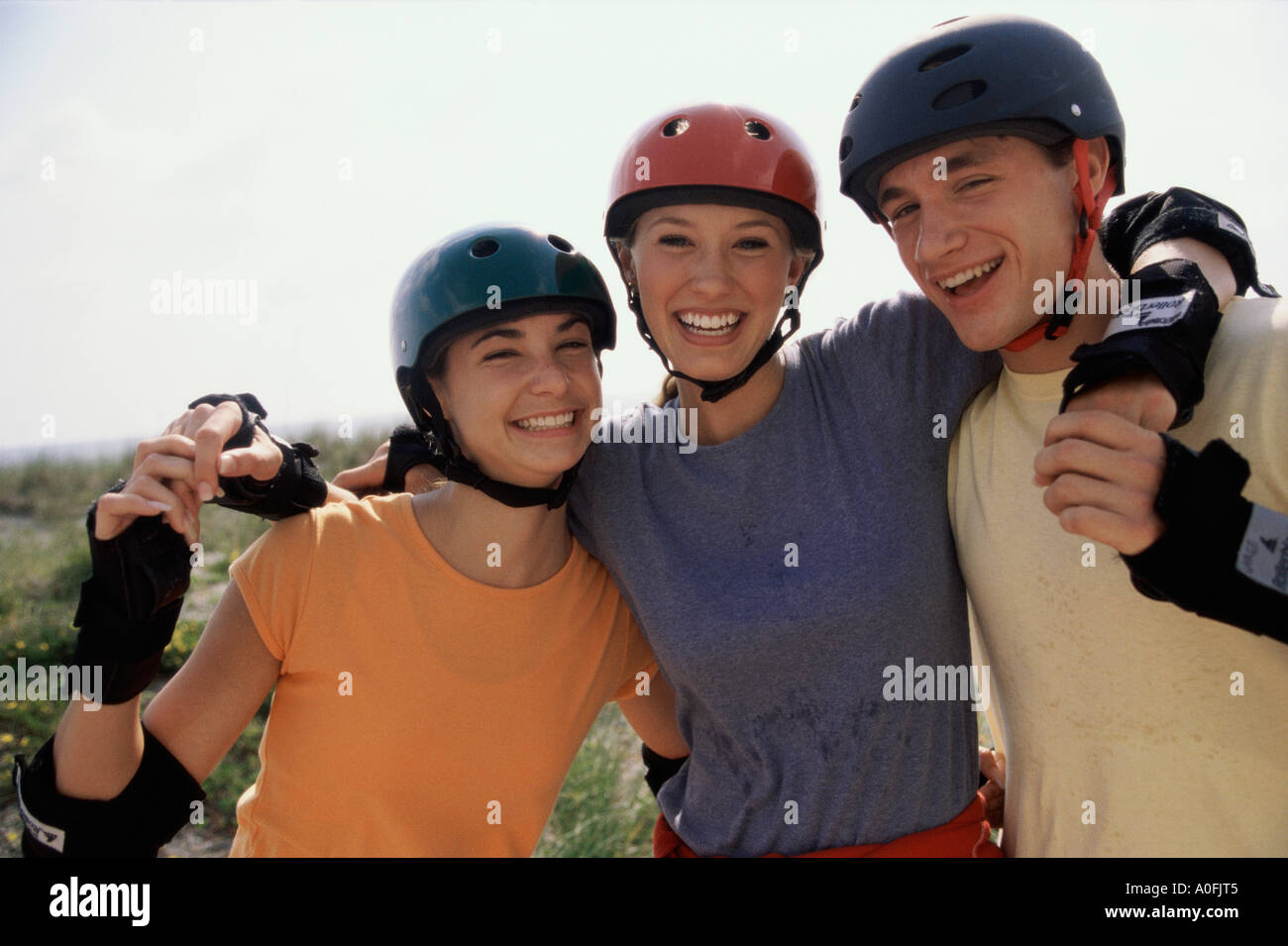 Portrait of two teenage girls and a teenage boy smiling Stock Photo - Alamy