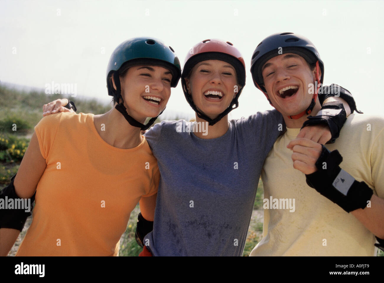 Portrait of two teenage girls and a teenage boy smiling Stock Photo - Alamy