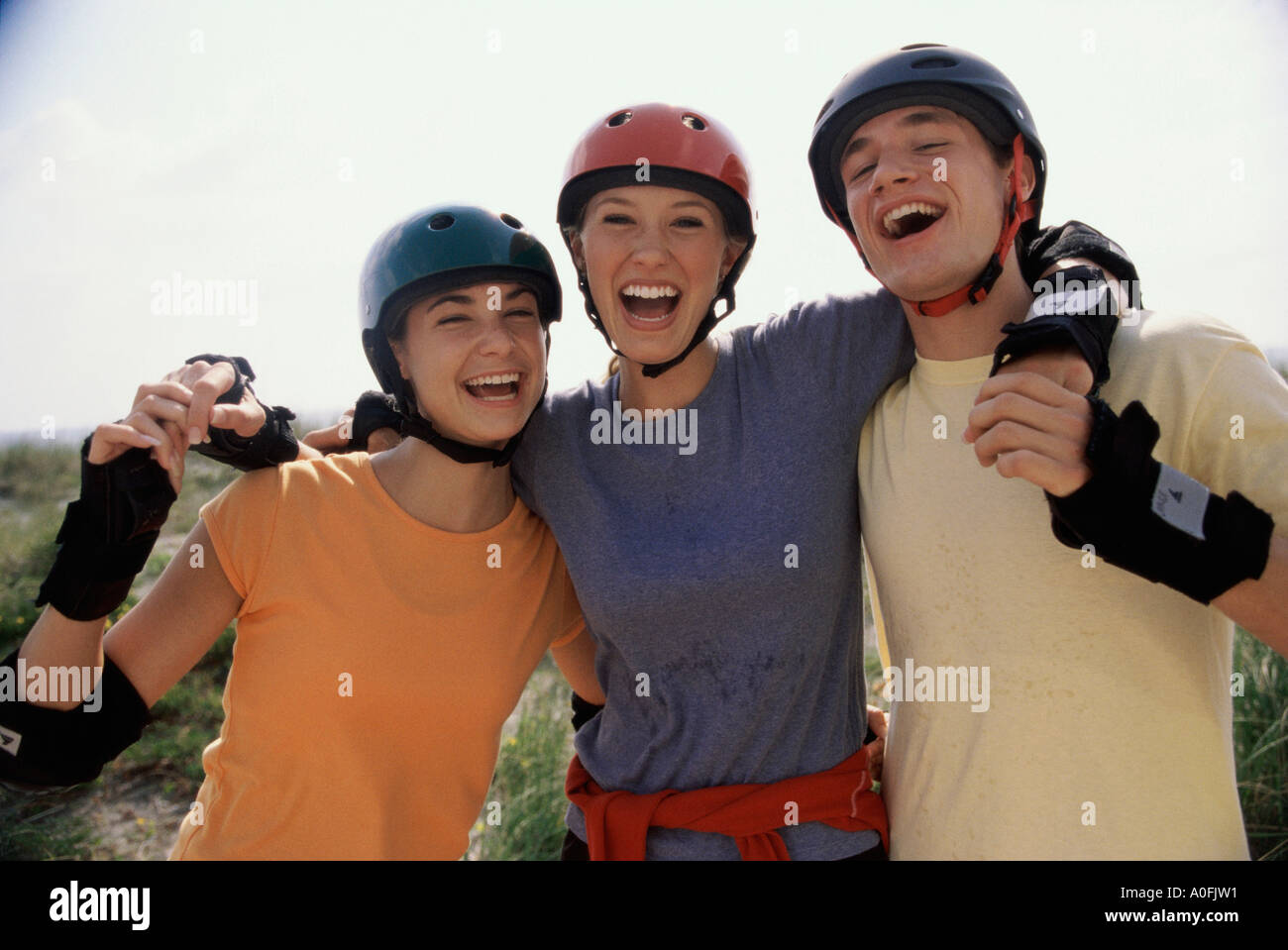 Portrait of two teenage girls and a teenage boy smiling Stock Photo - Alamy