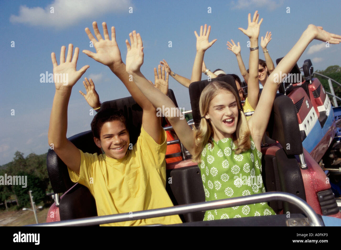 Group of teenagers riding a rollercoaster Stock Photo - Alamy