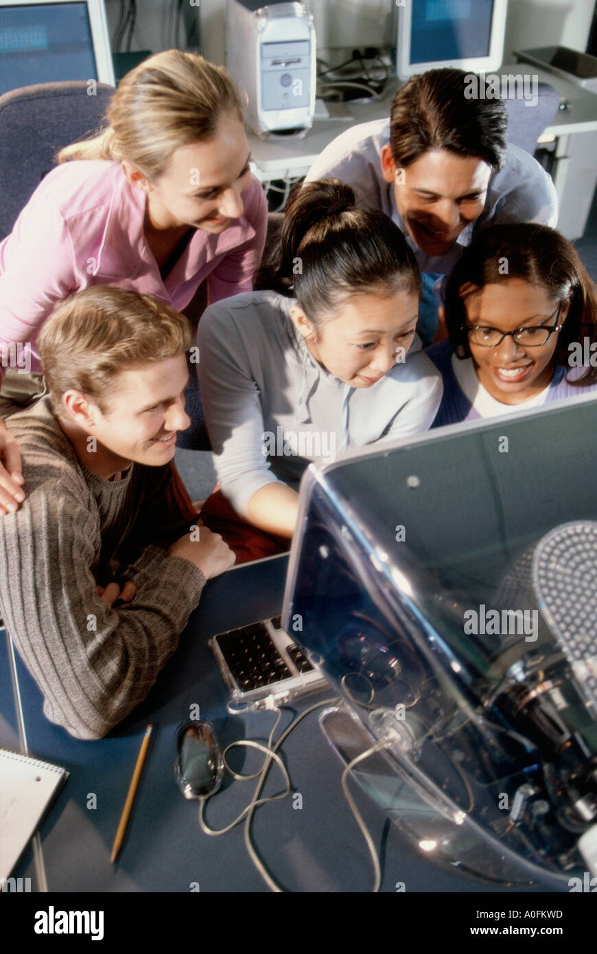 Group of young people in front of a computer monitor Stock Photo - Alamy