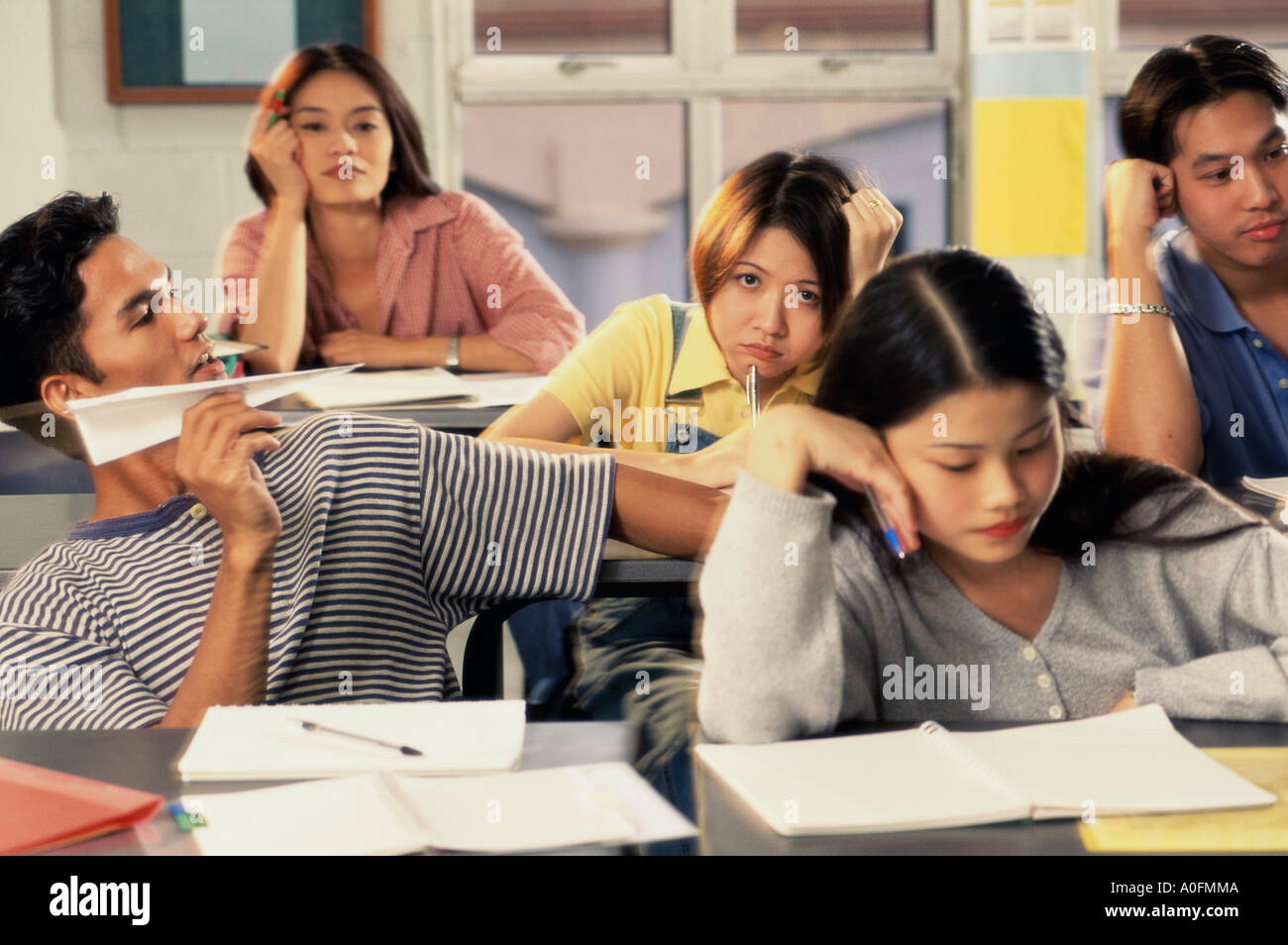 Group of teenagers sitting in a classroom Stock Photo - Alamy