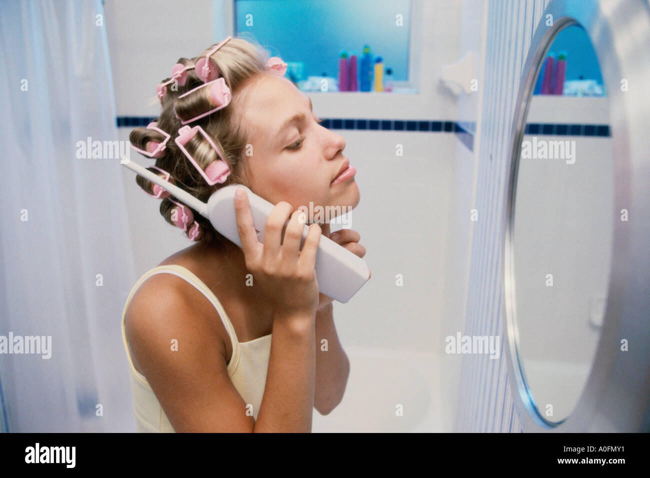Side profile of a teenage girl looking into a mirror Stock Photo - Alamy