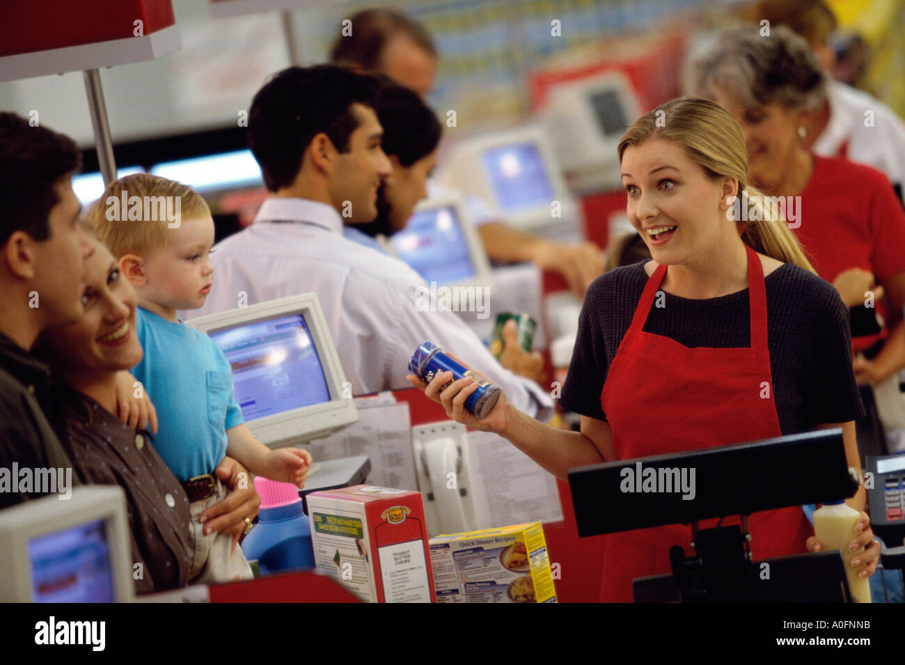Customers standing at a checkout counter in a supermarket Stock Photo ...